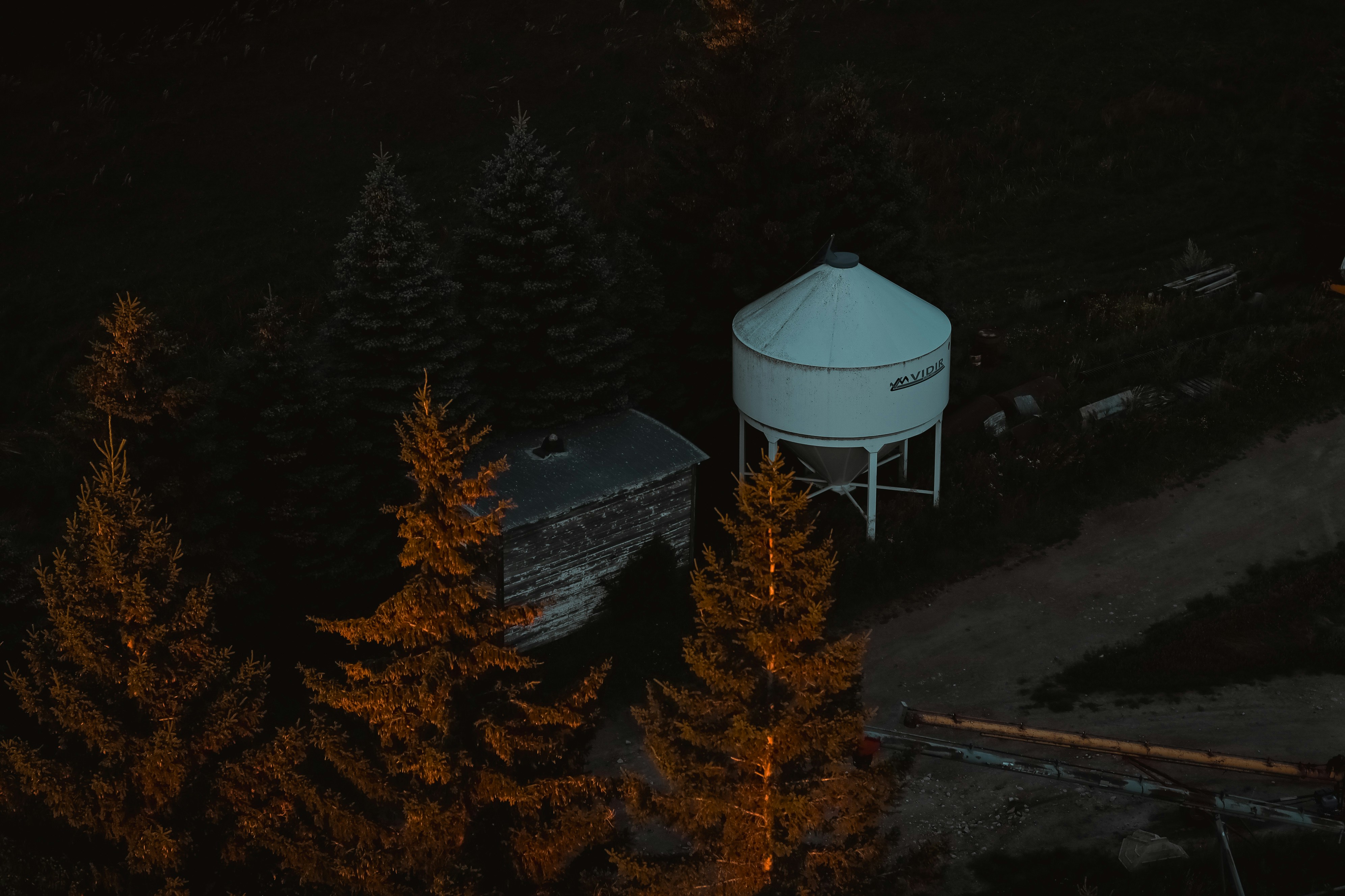 An aerial view of a water tower at night photo – Free Sunset Image on ...