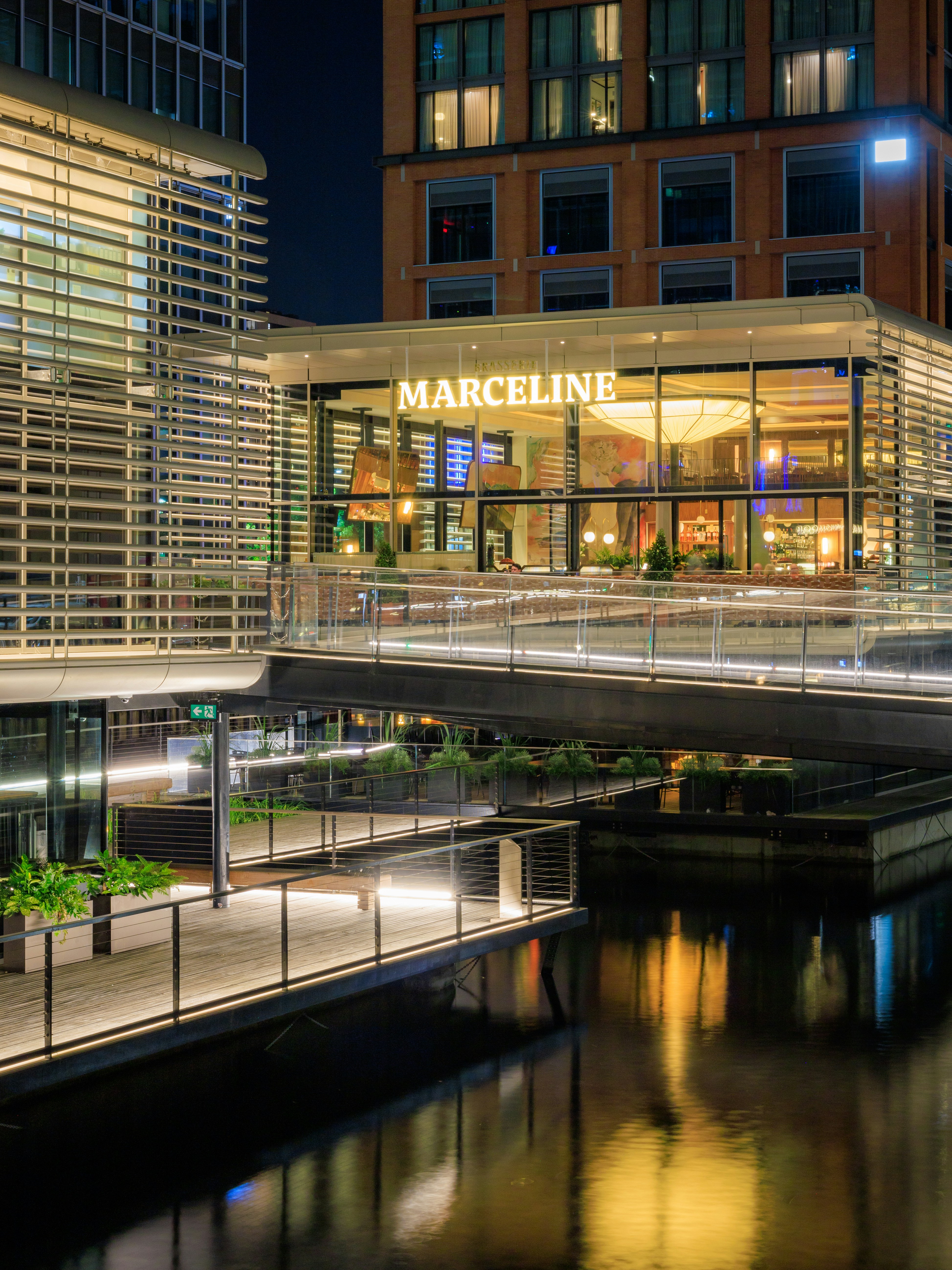 Marceline's Night Walkway: Glass, Water, and Warm Light