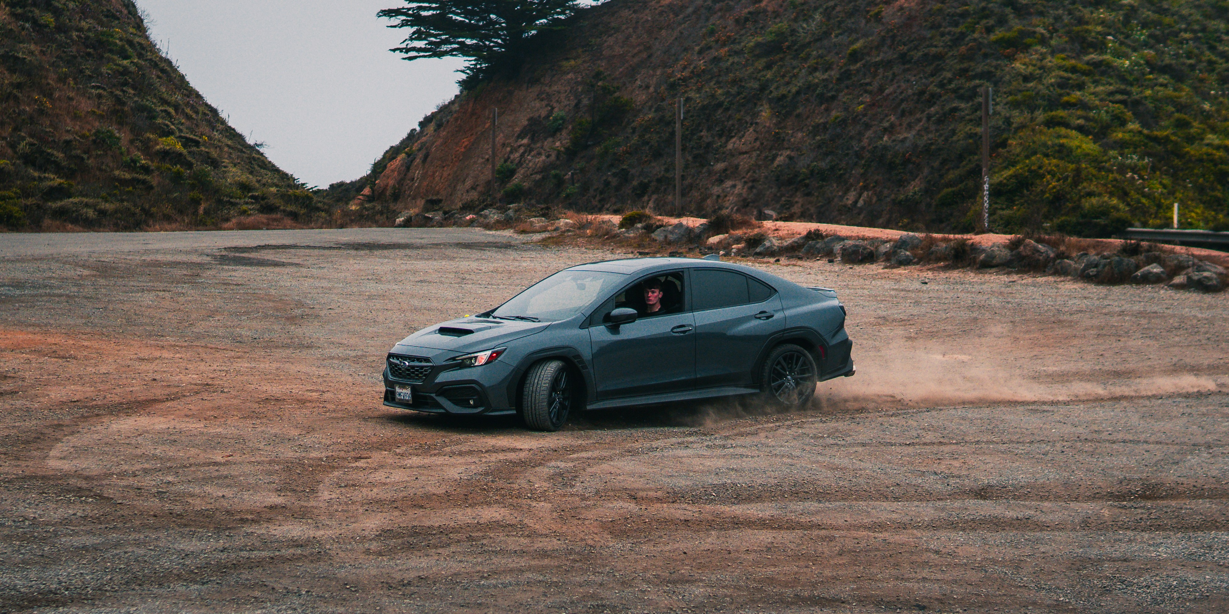 Coastal Drift: Cobalt coupe carving a dusty bend