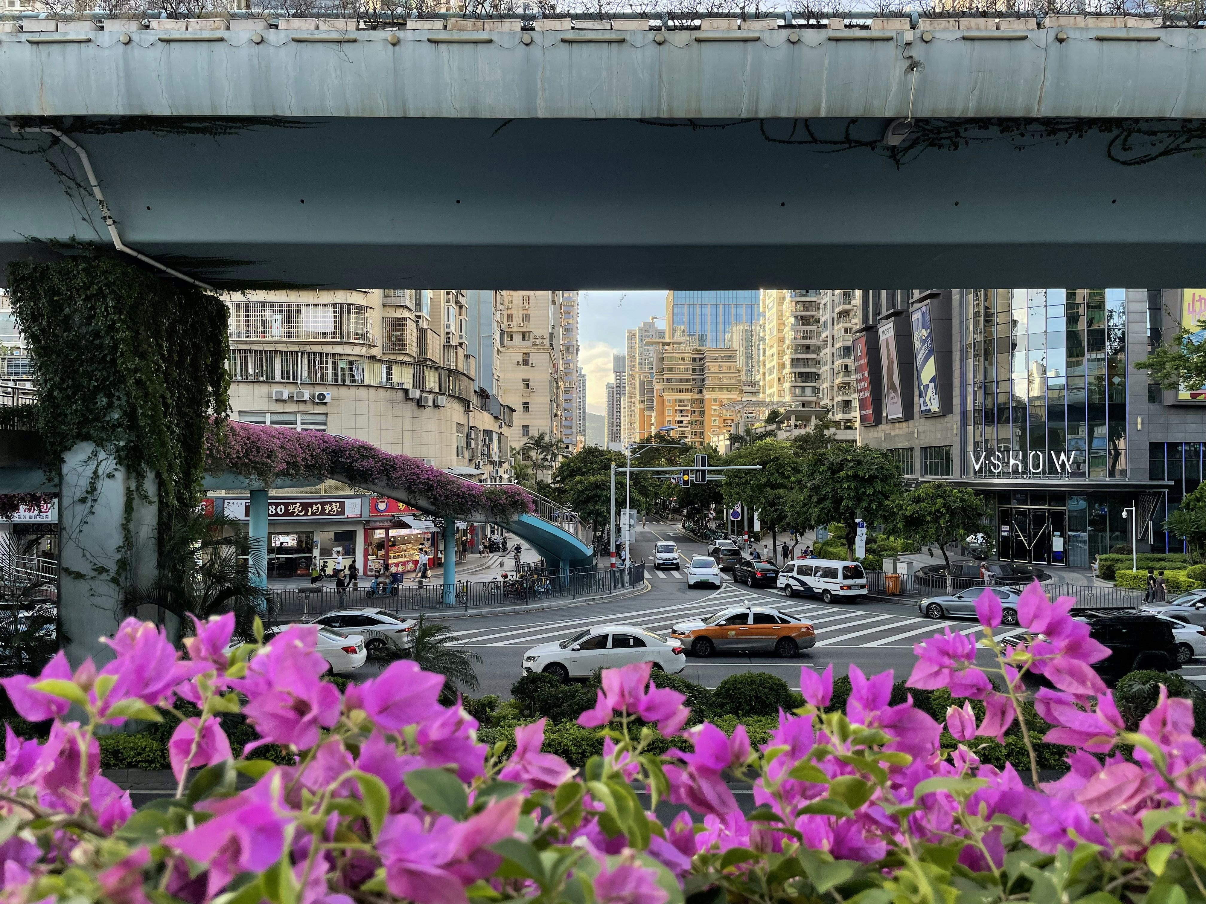 A city street filled with lots of traffic next to tall buildings photo ...