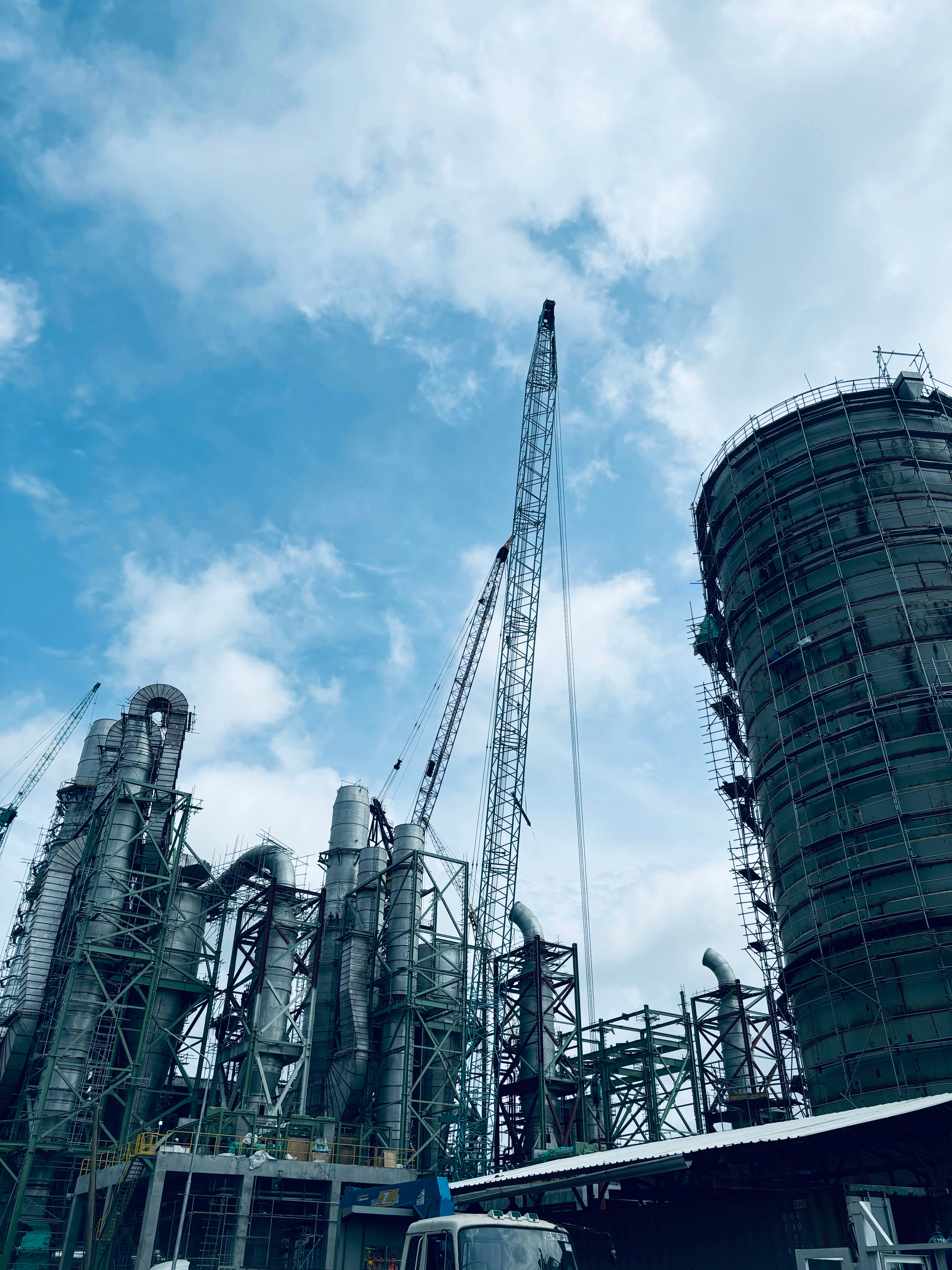Skyward Cranes: A Skeleton of Steel Rising Over the Industrial Yard