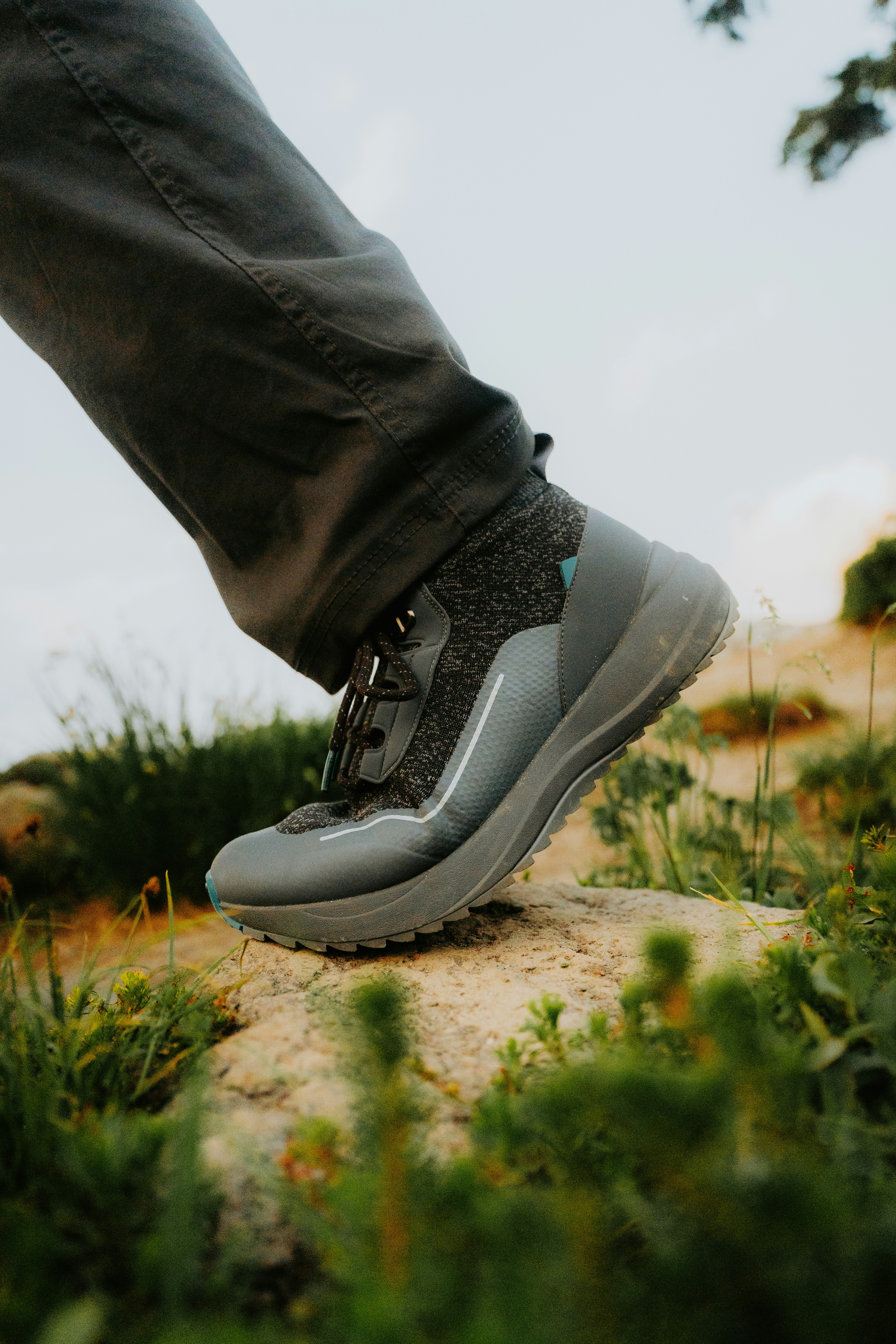 On the Edge of Light: a Rugged Trekker Grips a Sun-Warmed Rock