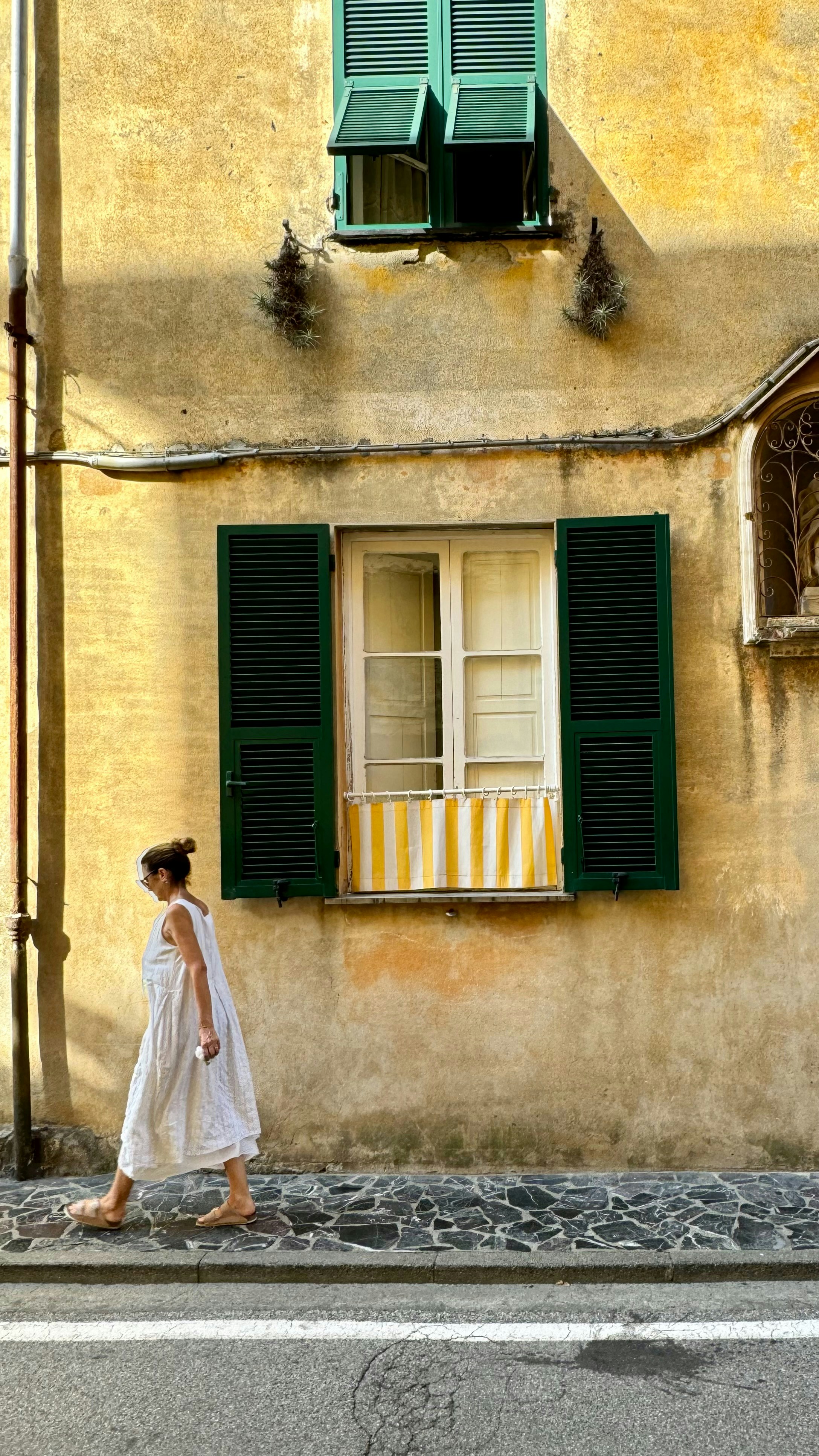 White Dress, Emerald Shutters, and a Sunny Facade Walk