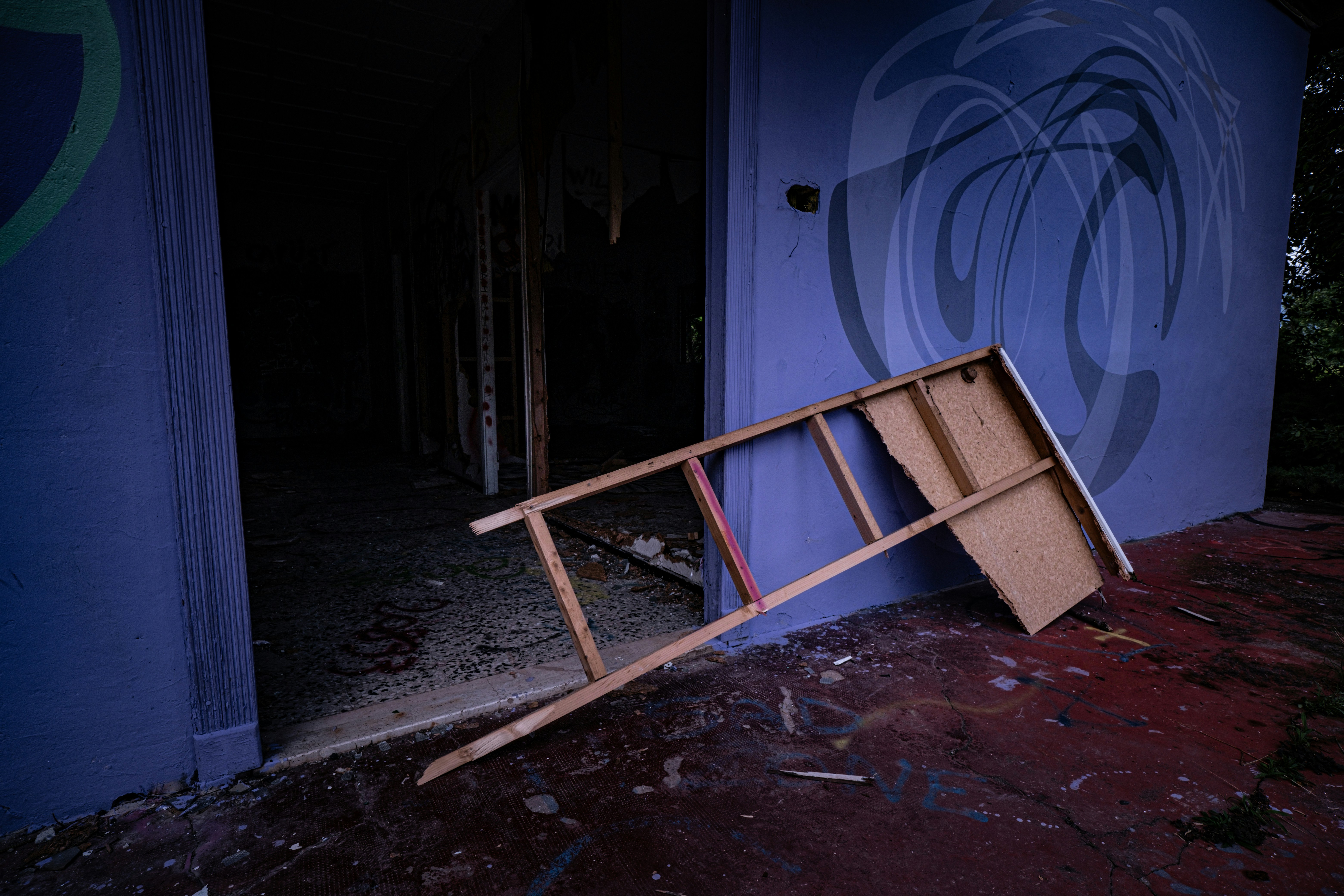 Tilted Relic at the Ruin's Threshold Under Indigo Graffiti