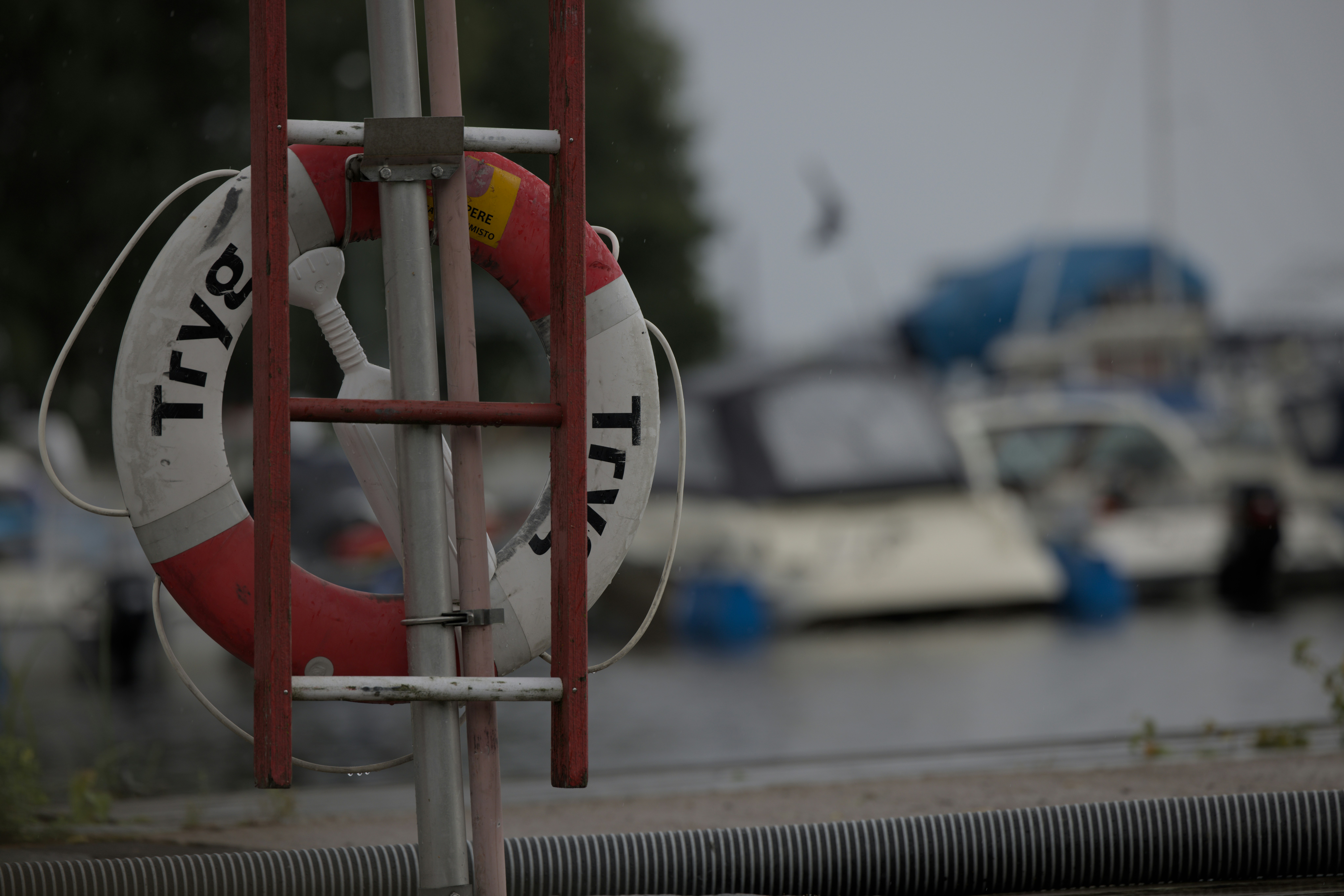 A red and white life preserver next to a body of water photo – Free ...