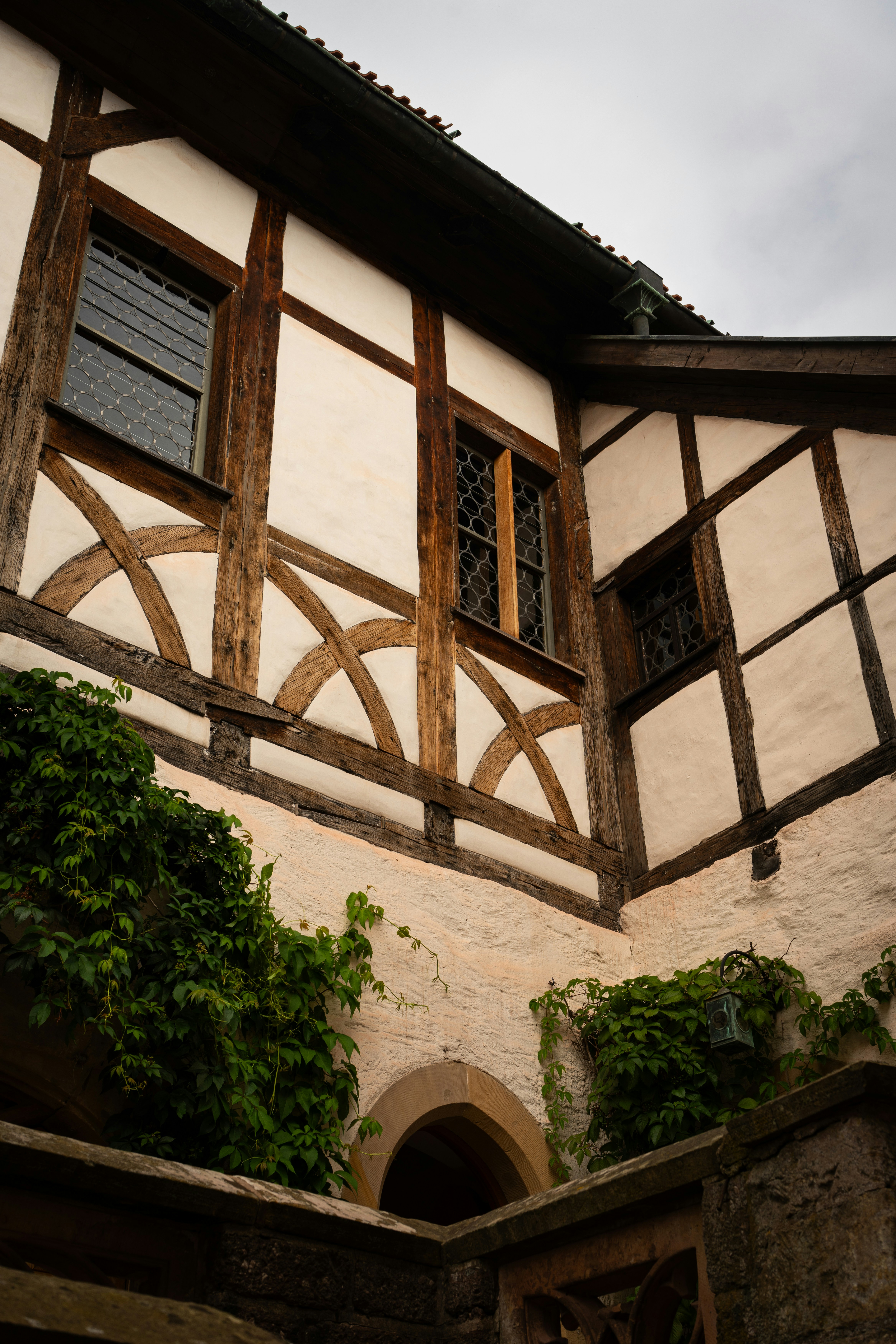 Ivy-Clad Archway Anchored by Timber-Framed Facade