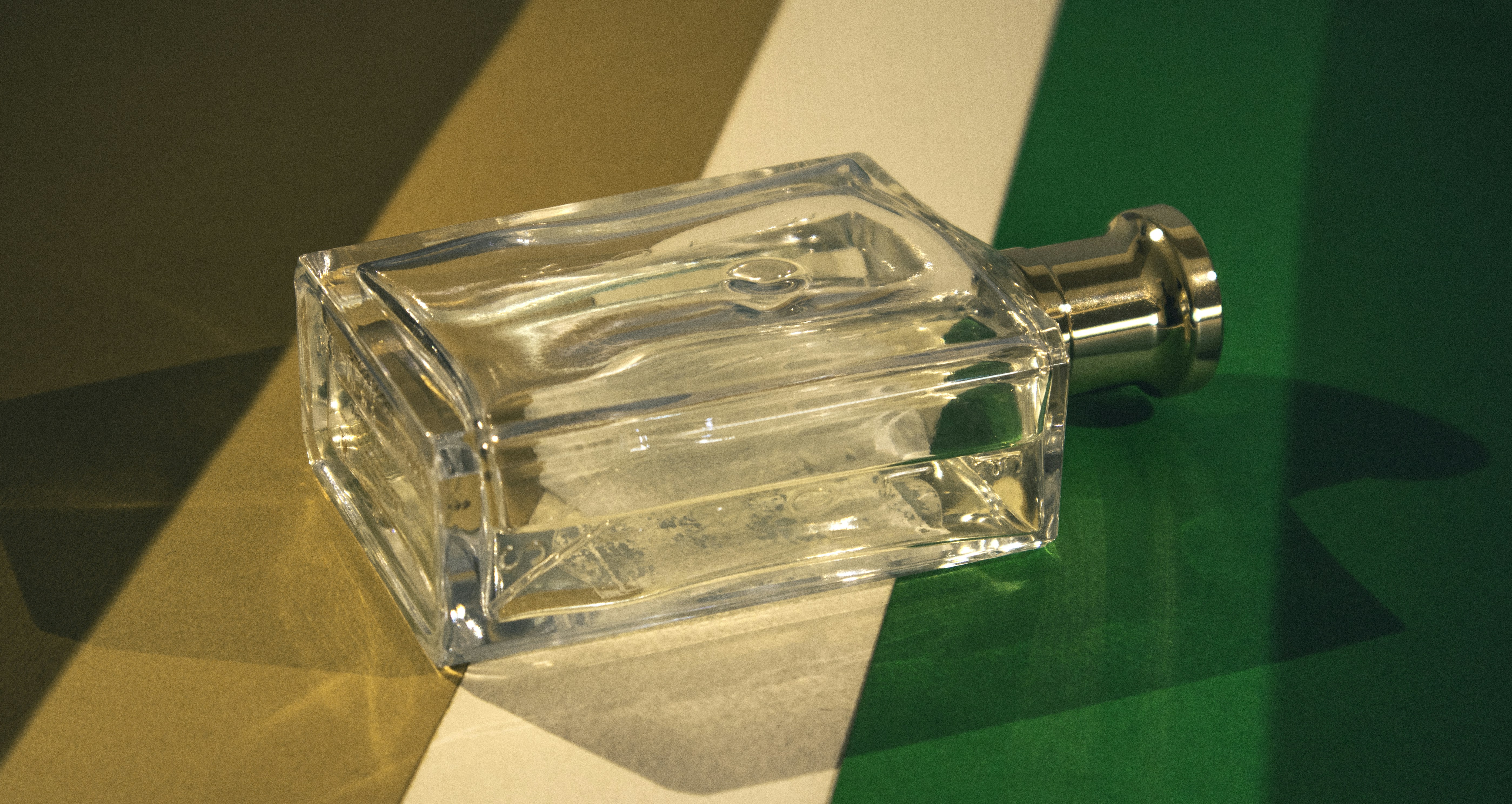 Geometric Spotlight on a Glass Perfume Bottle