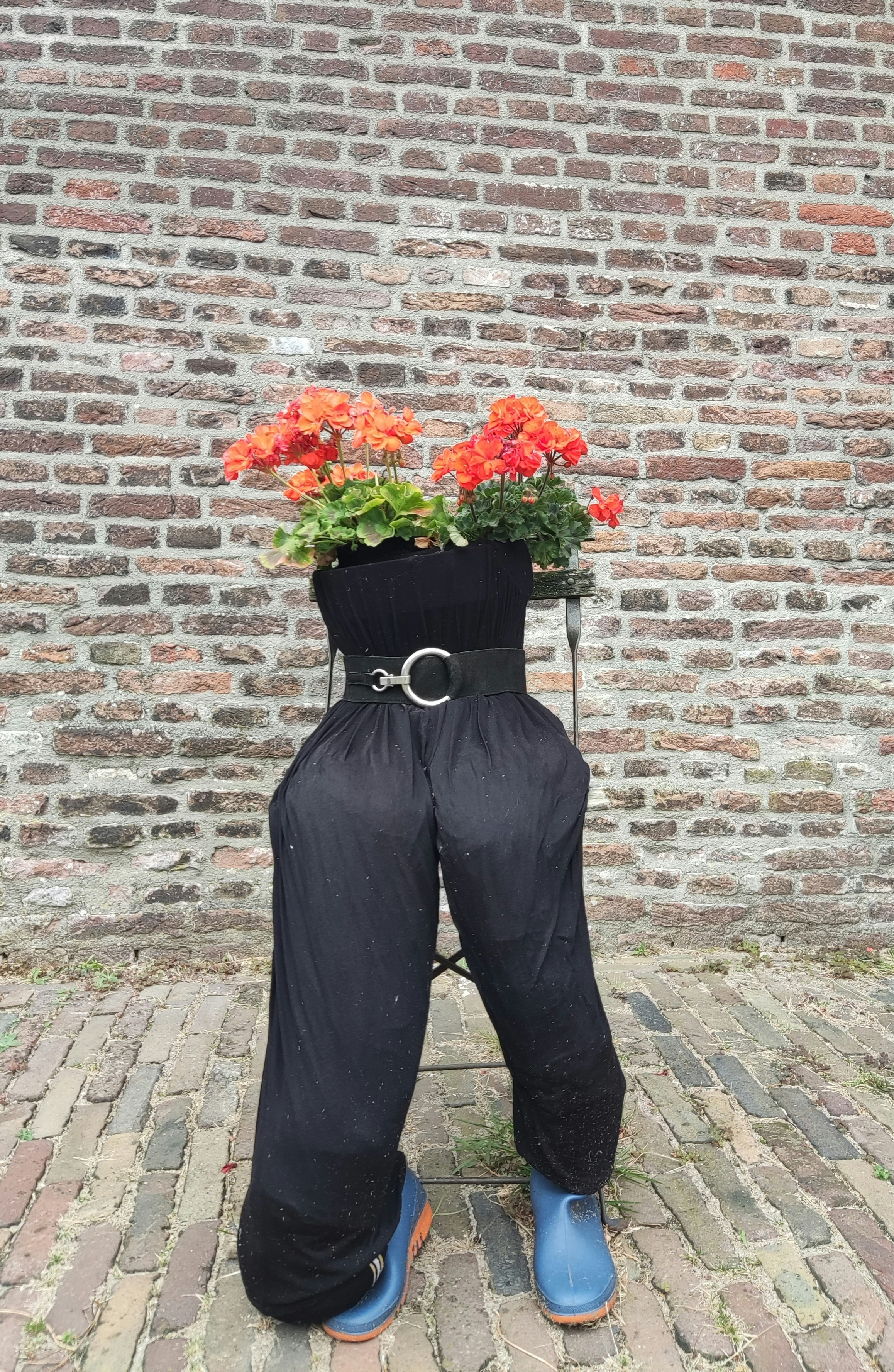 Floral Planter Portrait: A Living Sculpture Against a Brick Wall