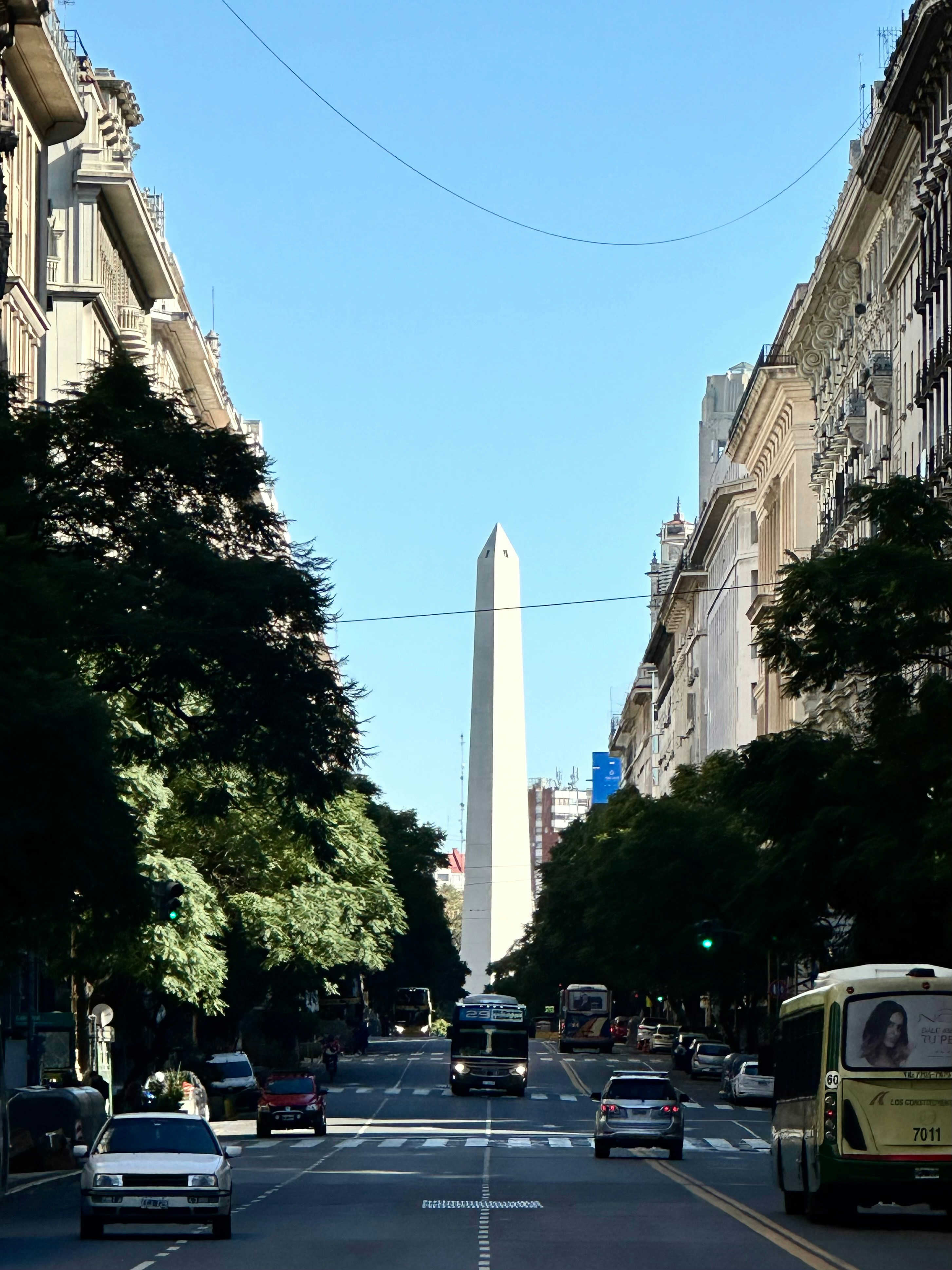The Avenue's Quiet Beacon: Obelisk Framed by Historic Facades