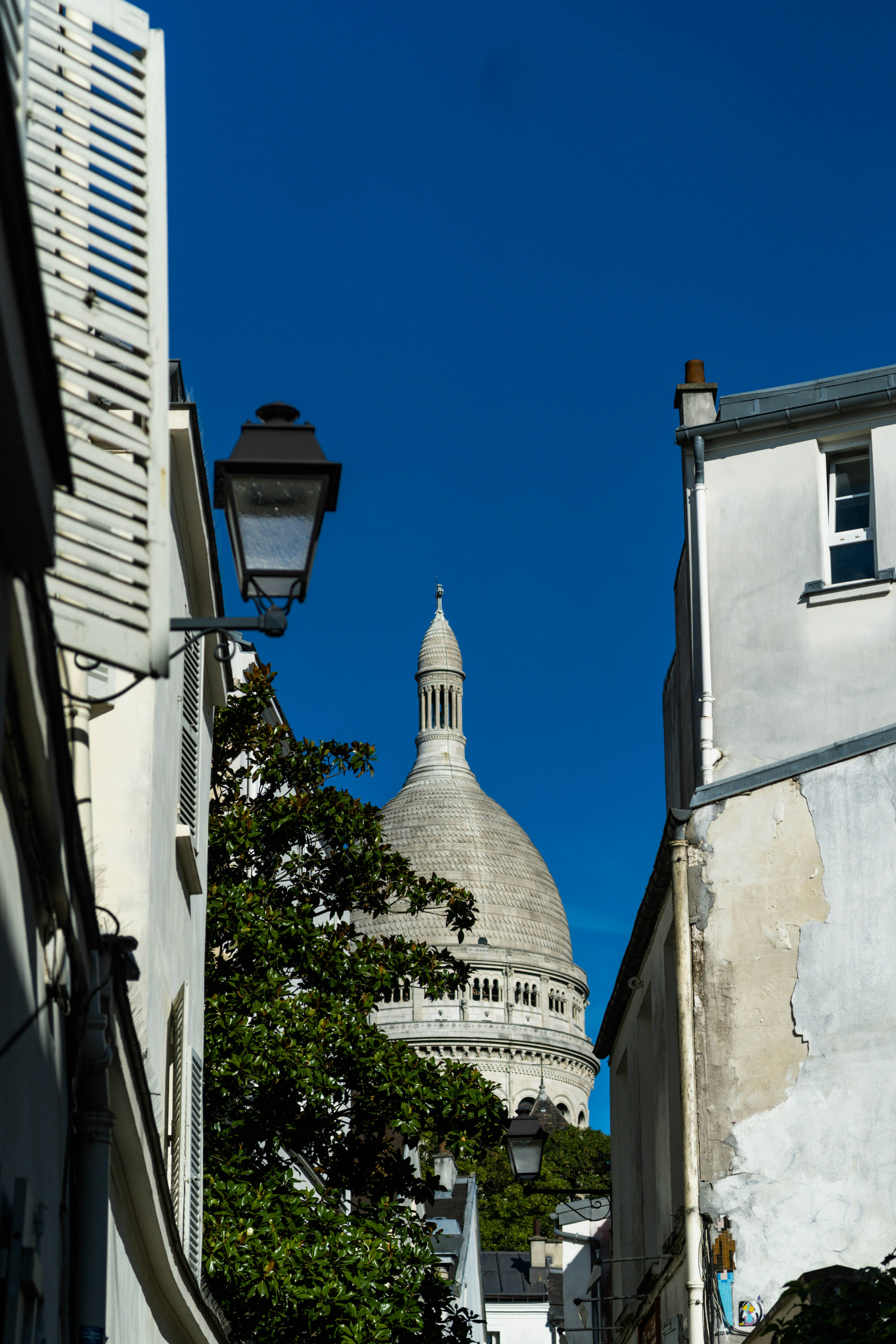 Alleyway to Montmartre: Sacré-Cœur Emerging Under Cerulean Sky