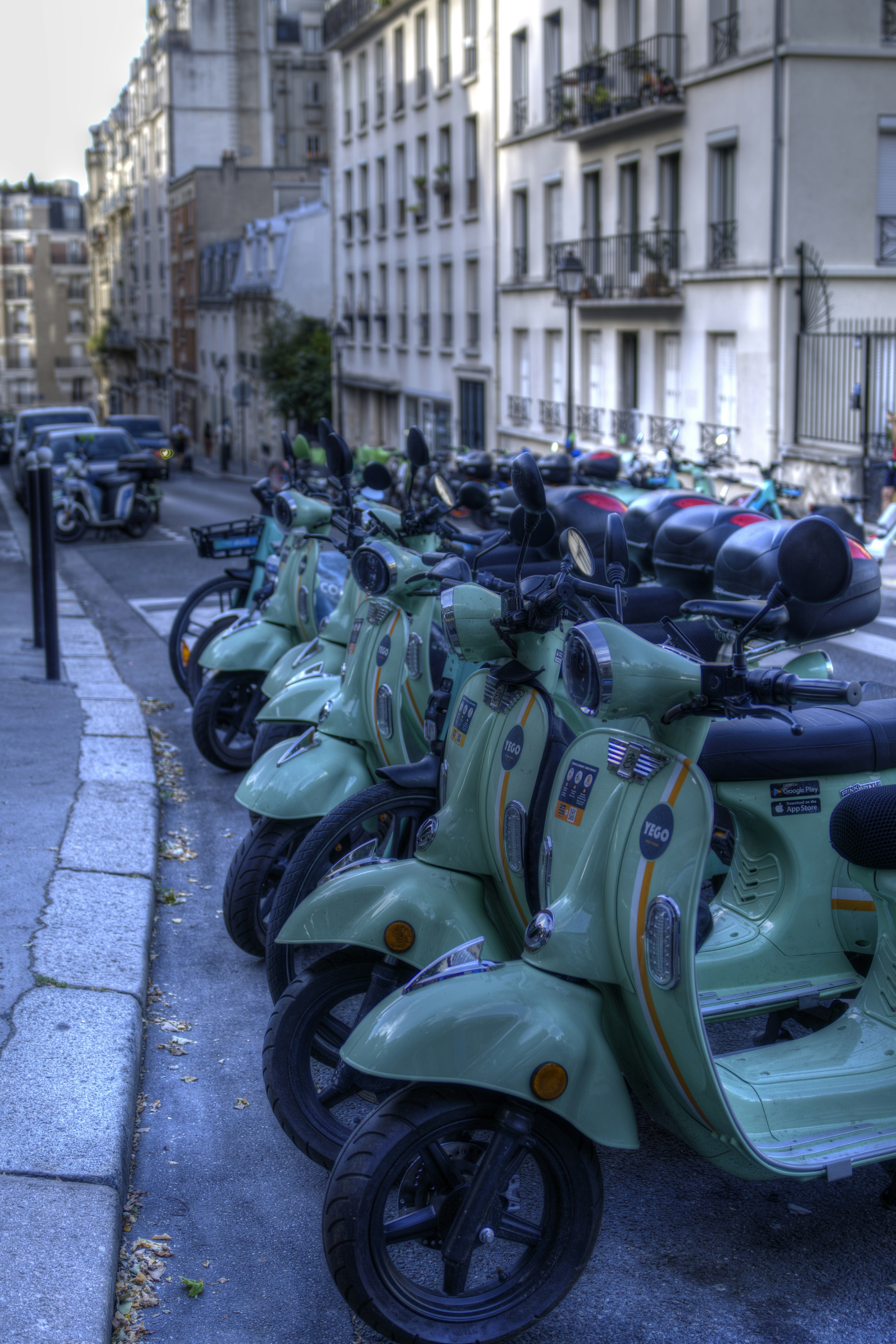 Mint Vespa Row Along a Parisian Street