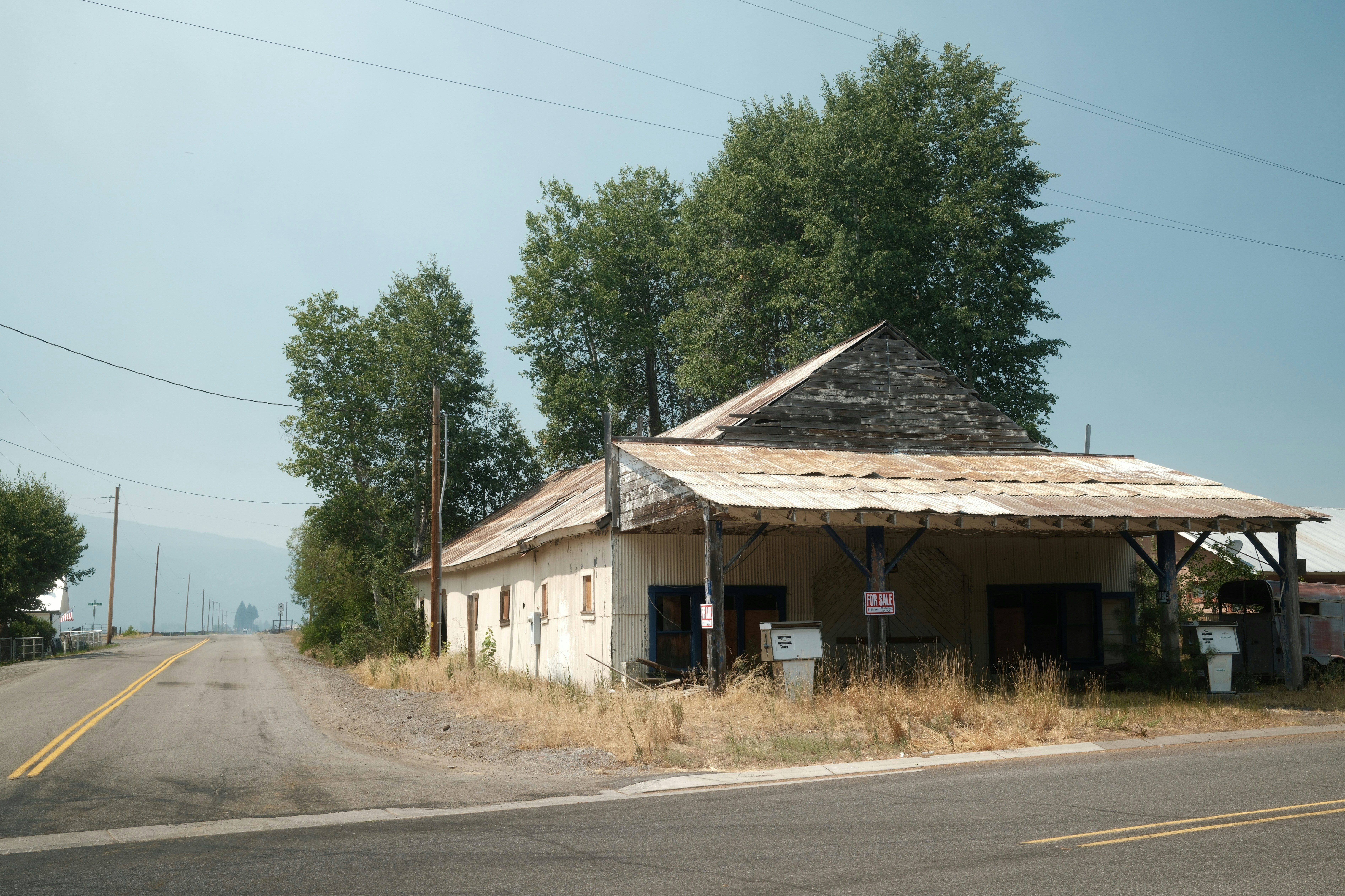 A run down building sitting on the side of a road photo – Free Oregon ...