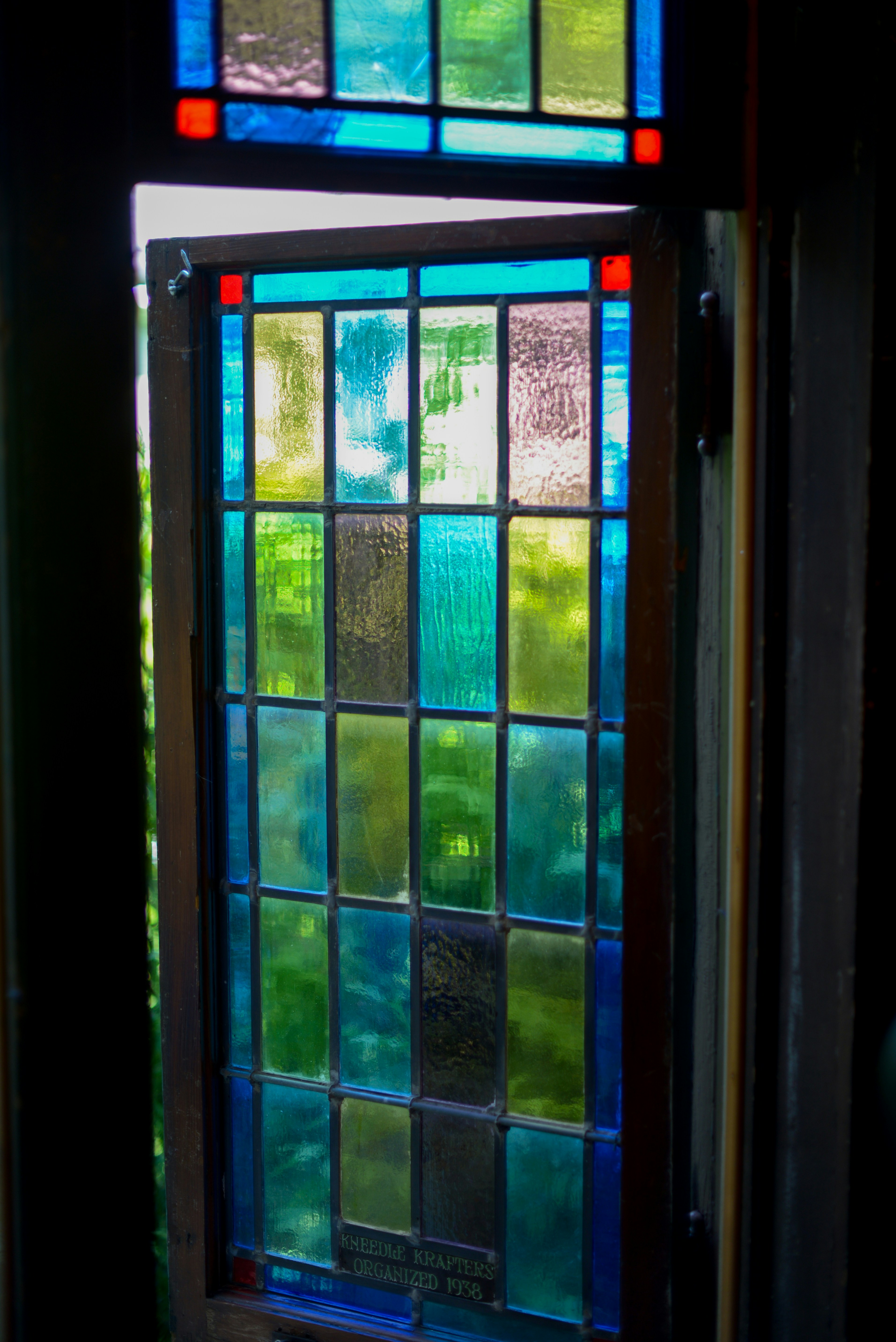 Verdant Lamplight: Light Between Blue-Green Glass Panels