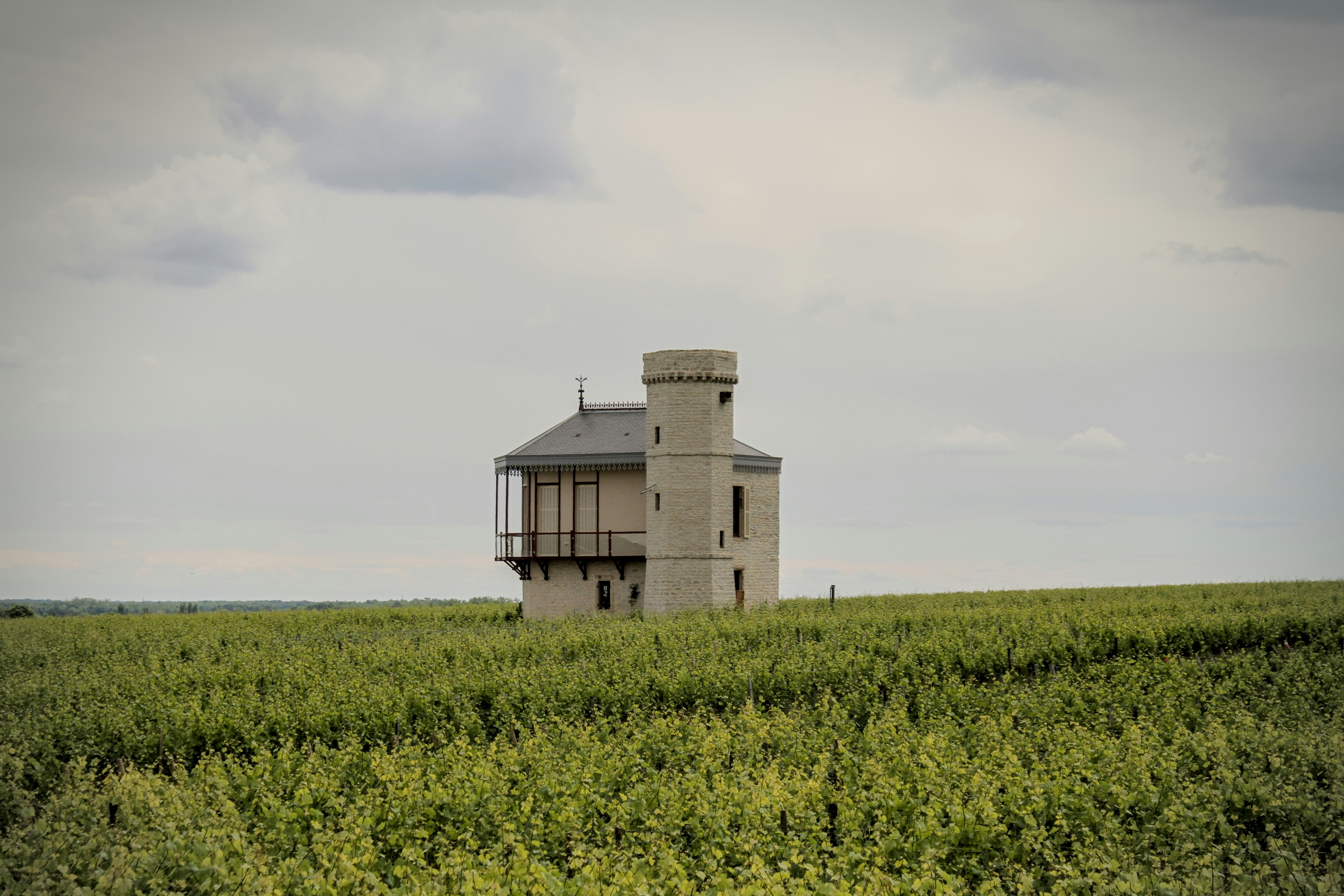Concrete Lookout in a Quiet Grain Field Under a Brooding Sky