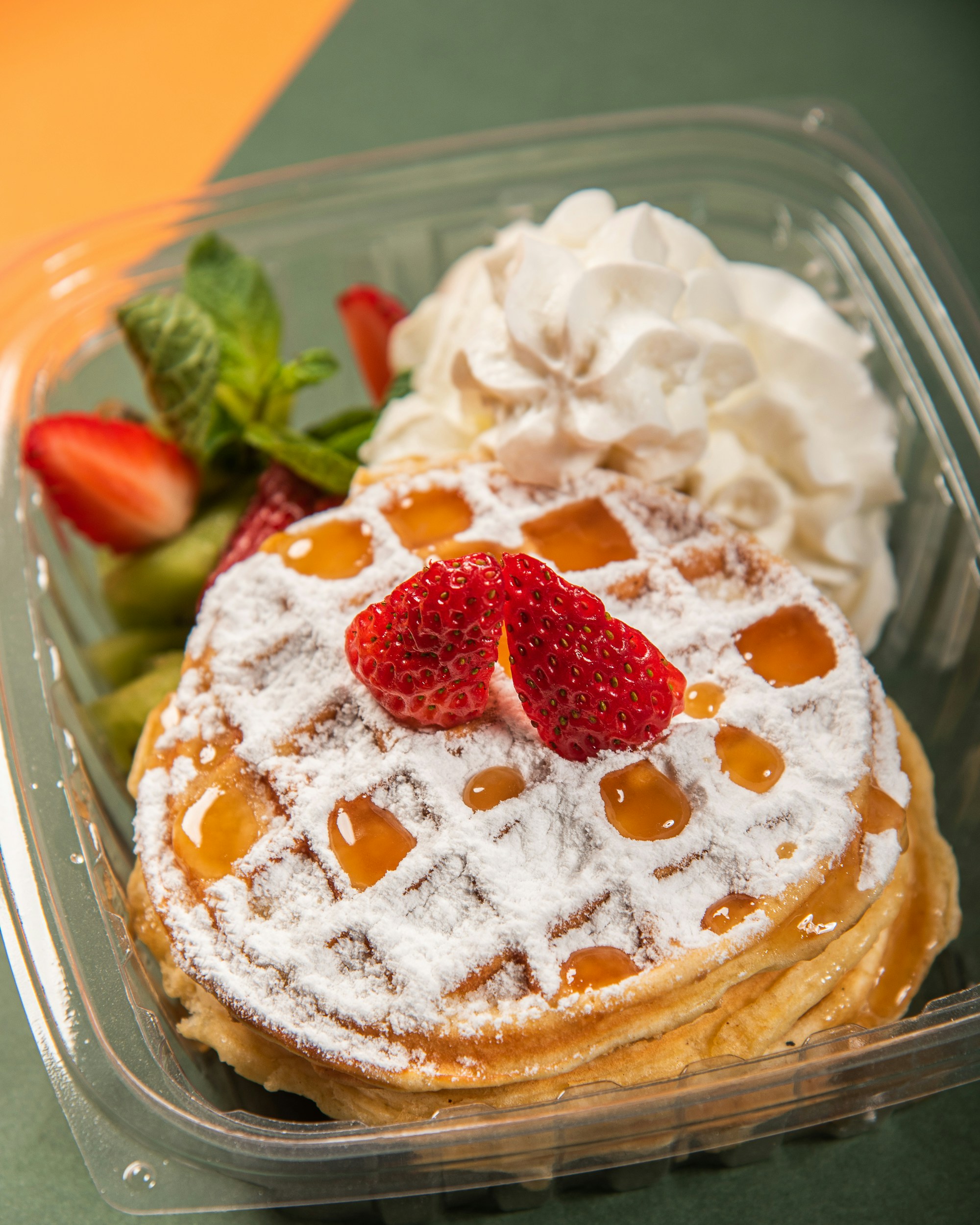 A plastic container filled with waffles and fruit photo – Free Dessert ...