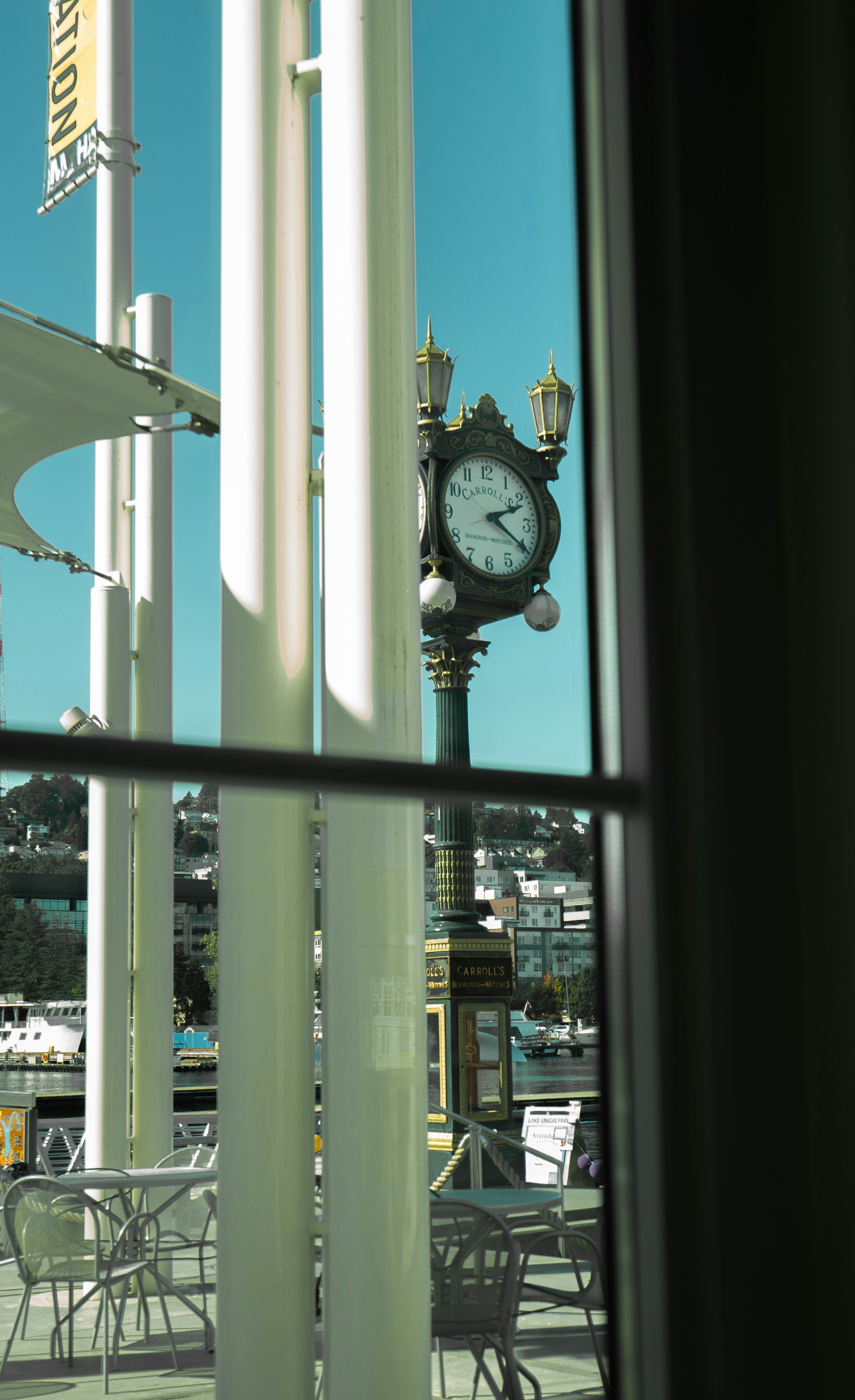 Timeless Waterfront Clock Framed by Glass and Columns
