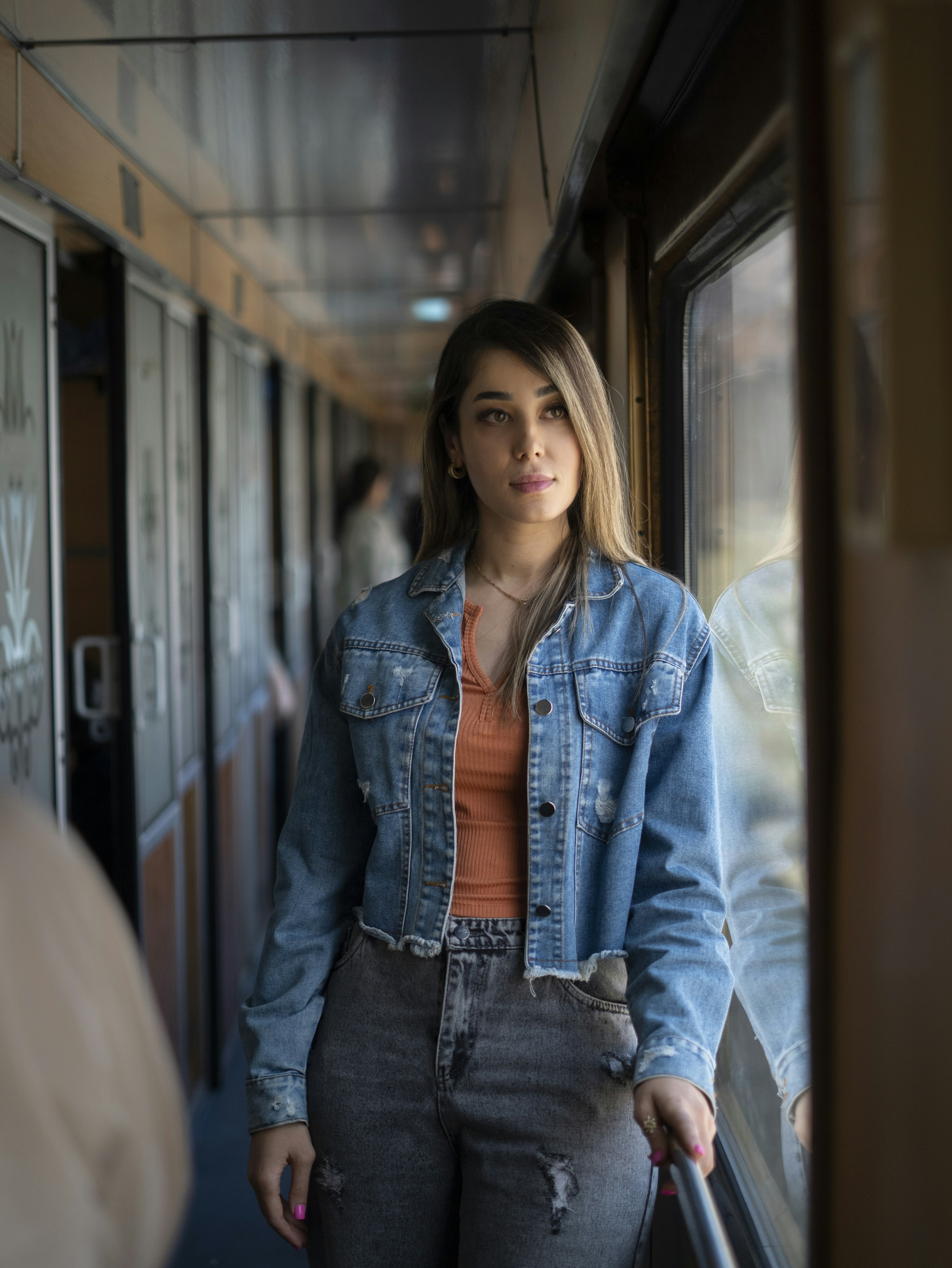 Mid-Carousel Portrait in a Neon-Gray Corridor