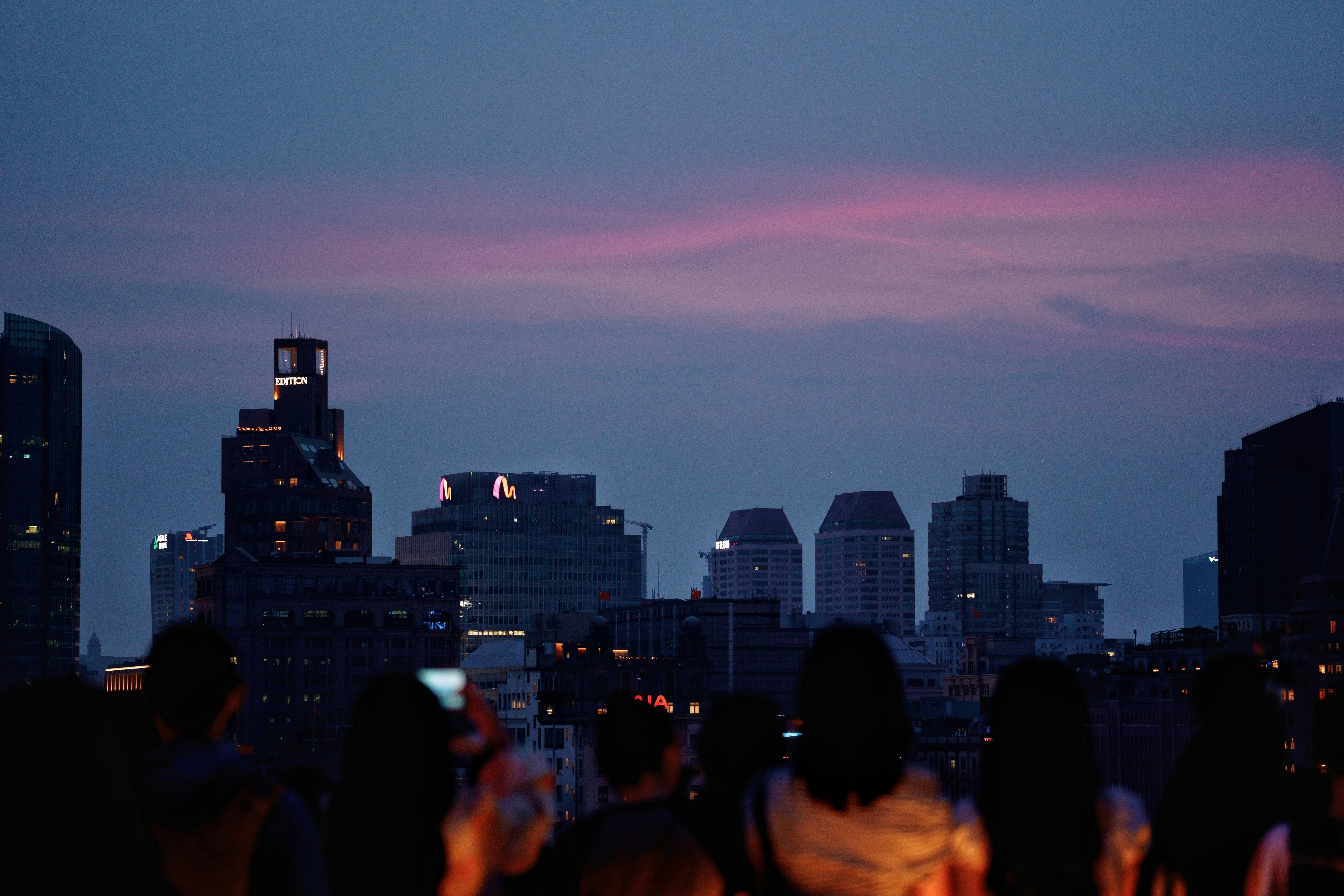 A group of people standing in front of a city skyline photo – Free ...