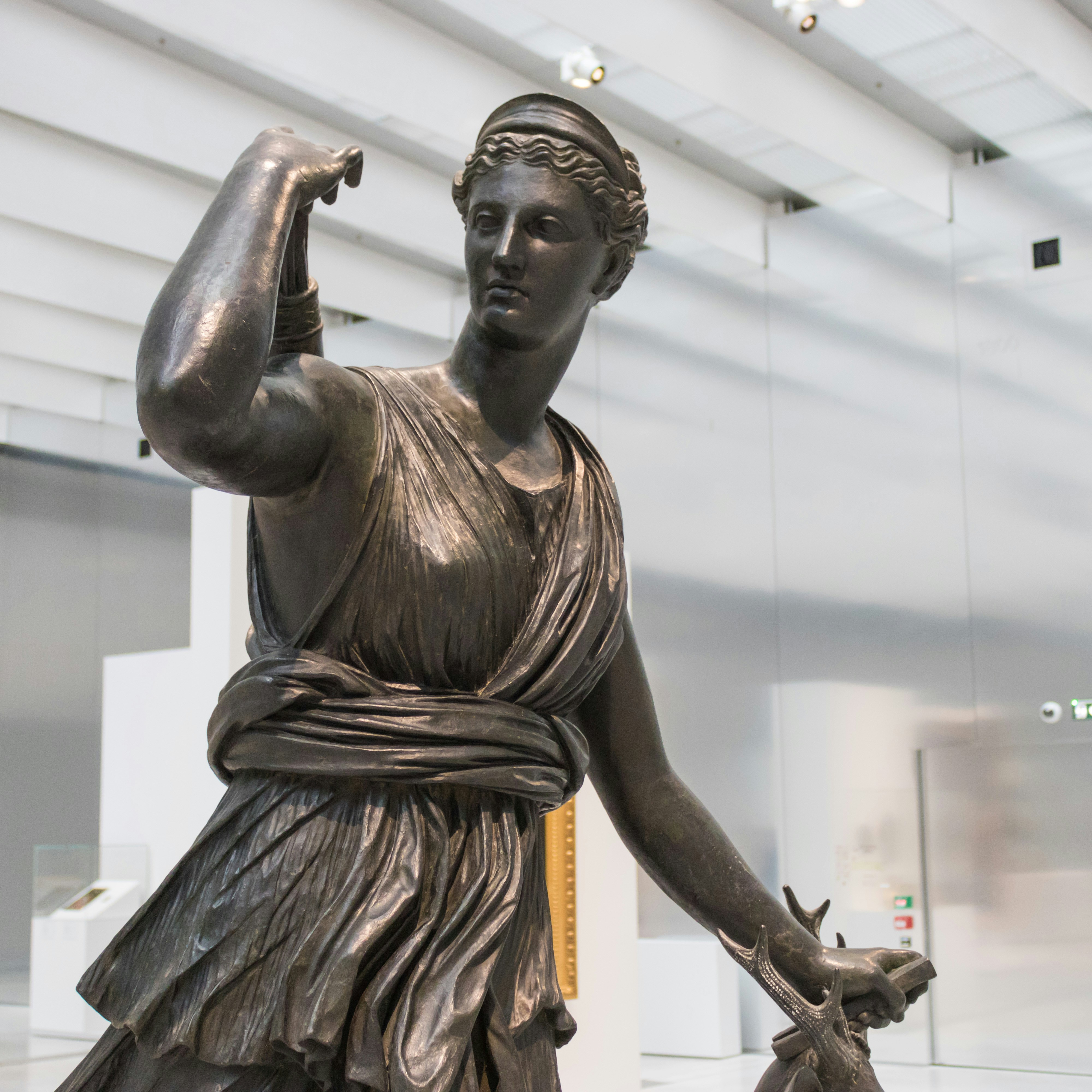 A bronze statue of a woman holding a dog