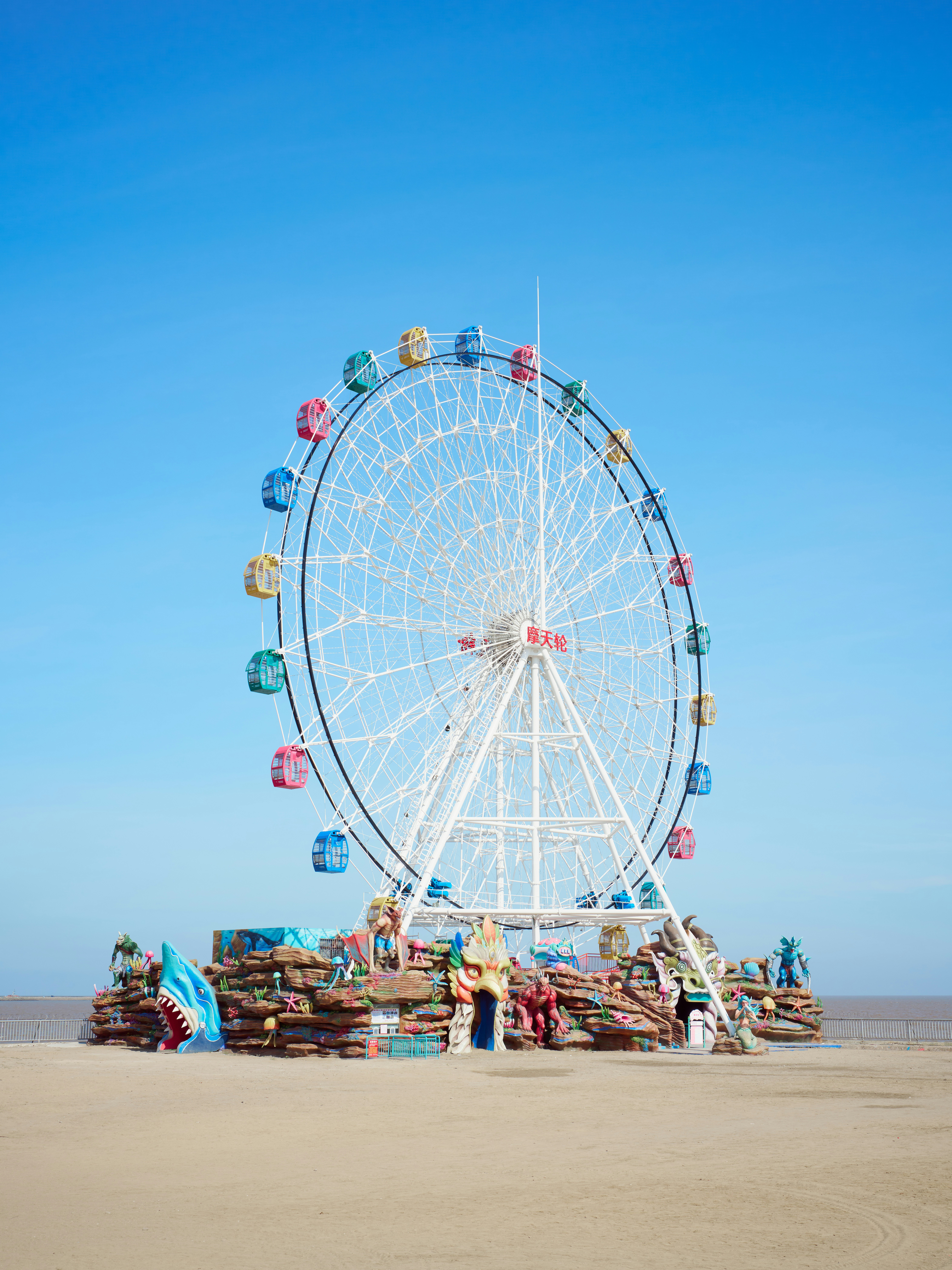 A ferris wheel sitting on top of a sandy beach