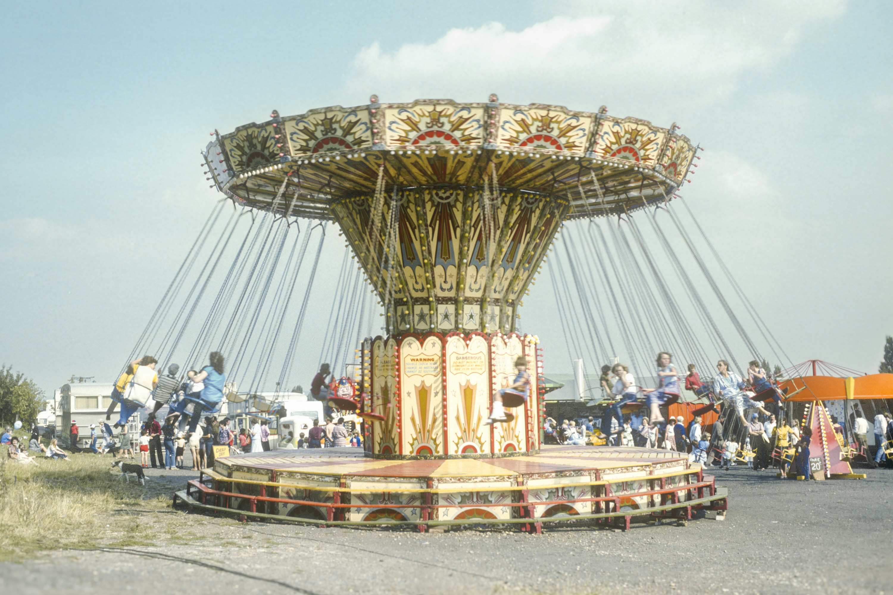 A merry go round in the middle of a parking lot photo – Free Film ...
