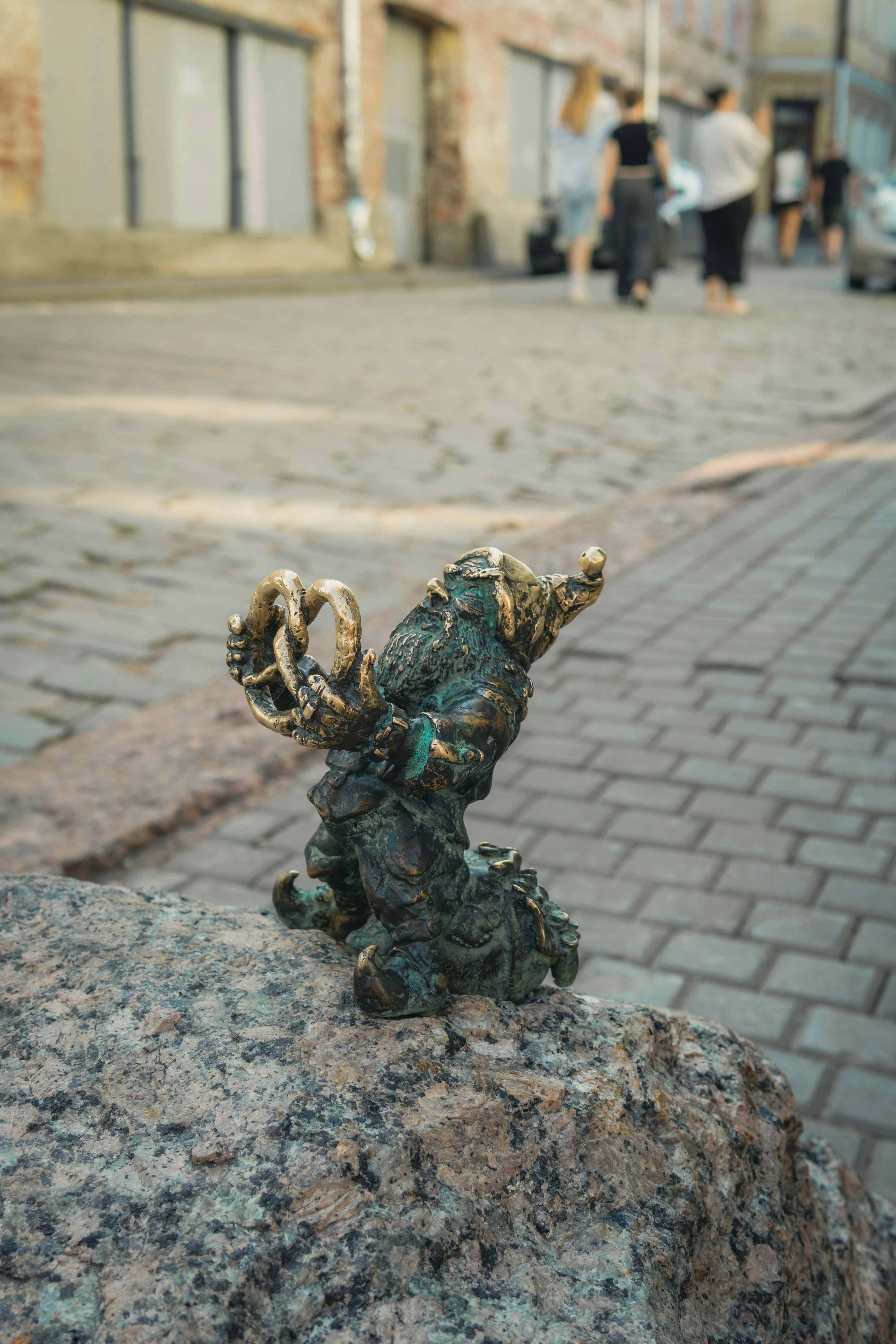Bronze Figure Reaching for the City’s Edge