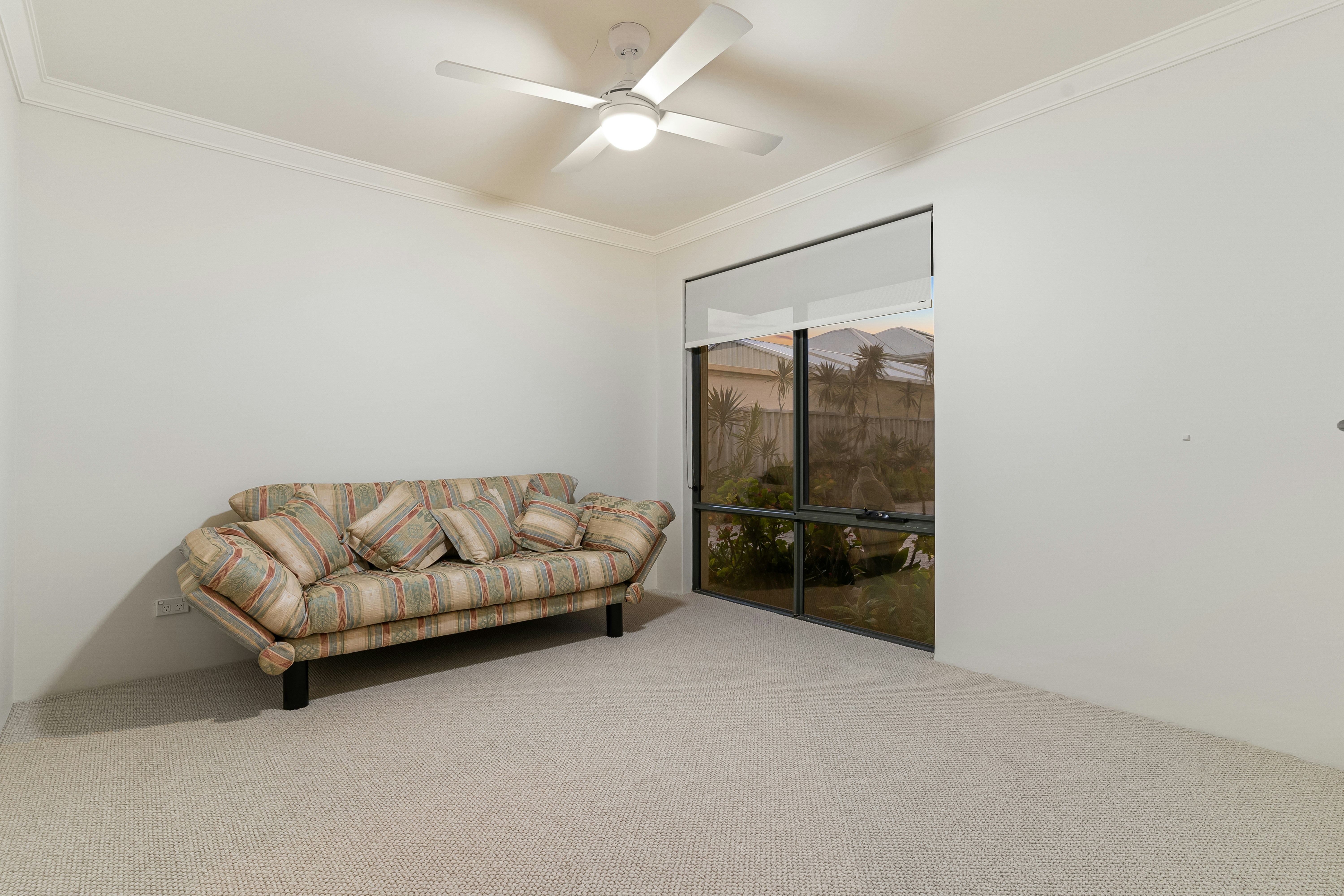 A living room with a couch and a sliding glass door photo – Free ...