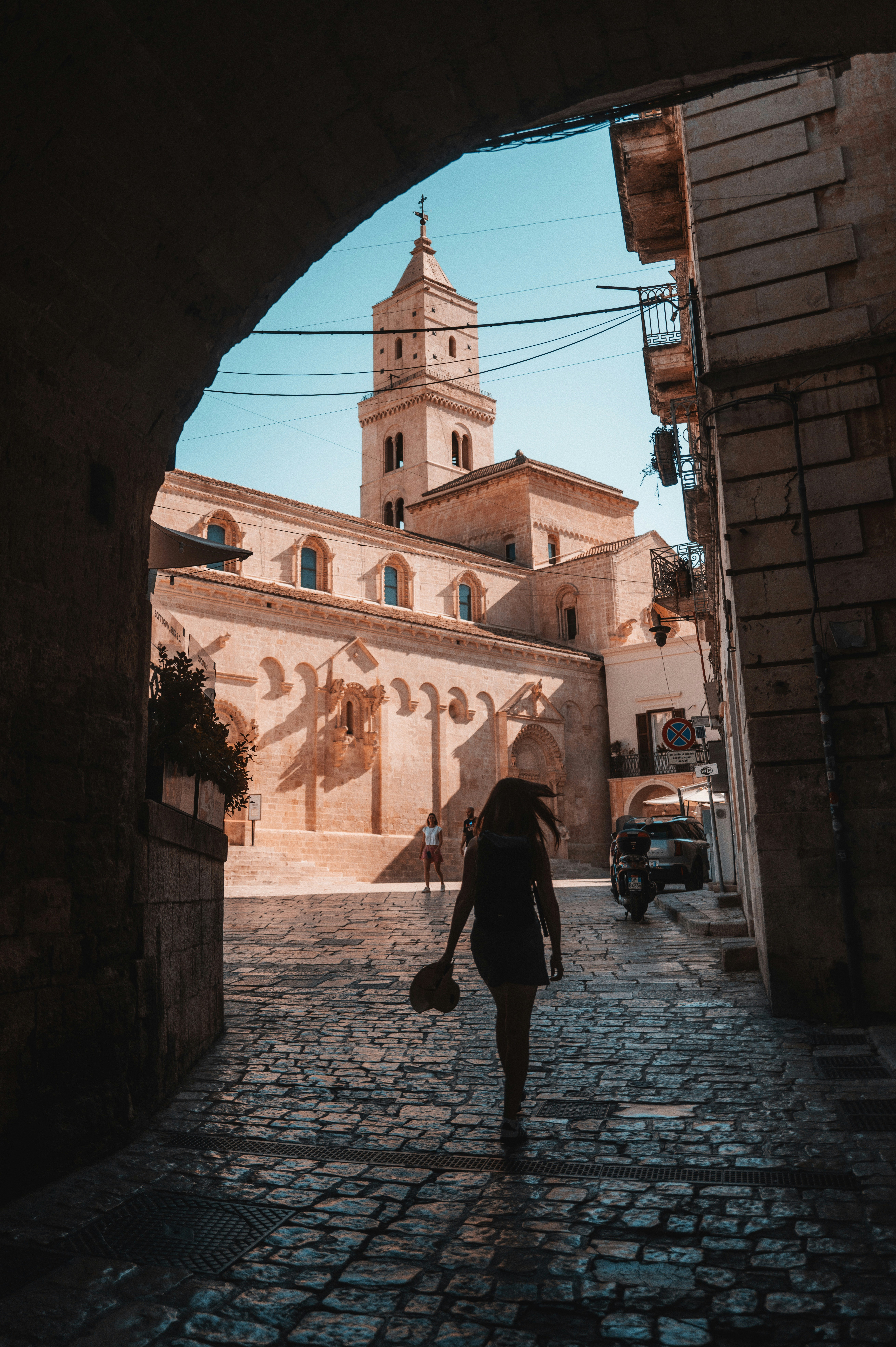 Cobbled Path to a Sunlit Bell Tower