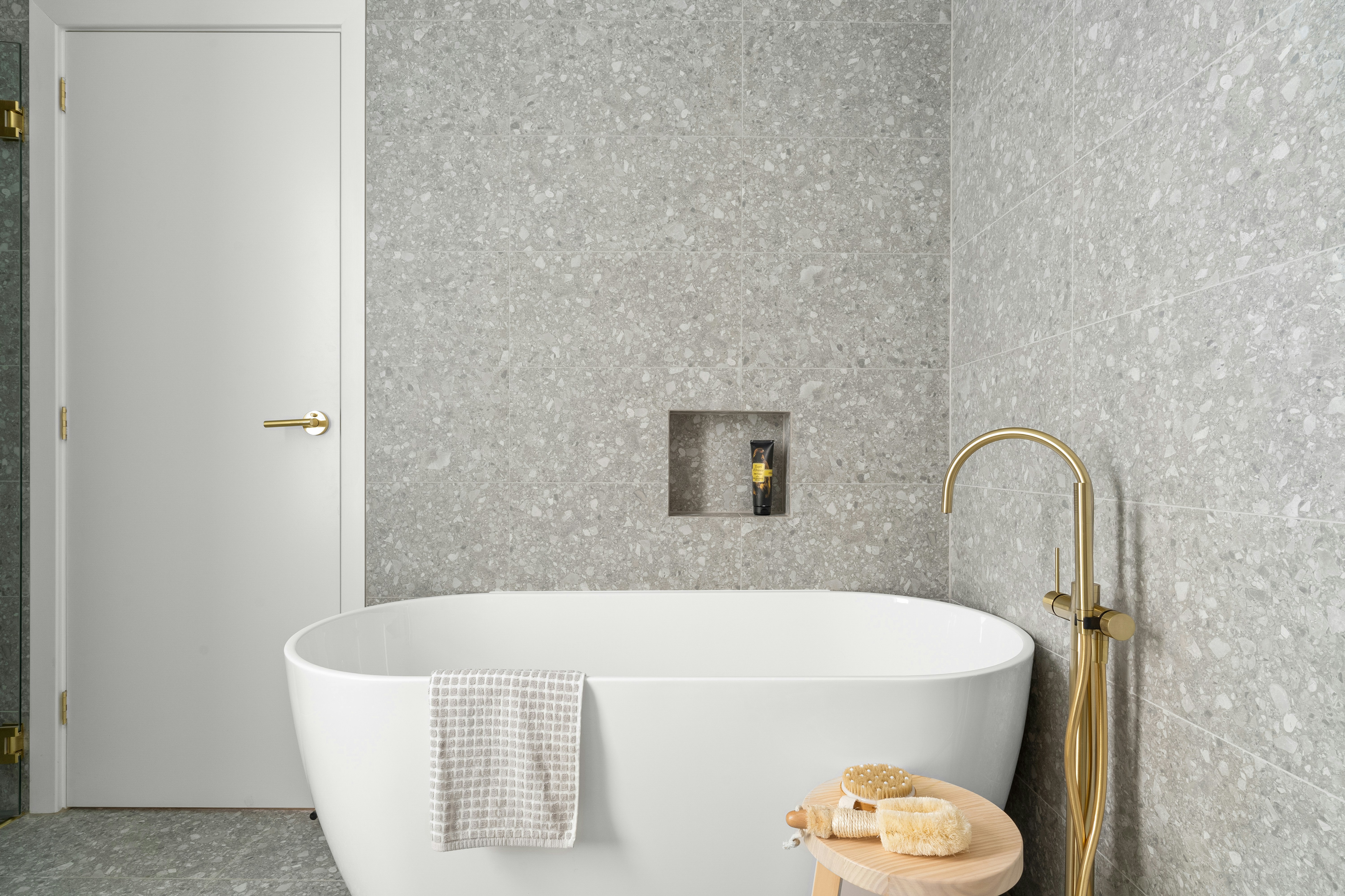 Minimalist Spa: Freestanding Bathtub centerpiece in terrazzo bathroom