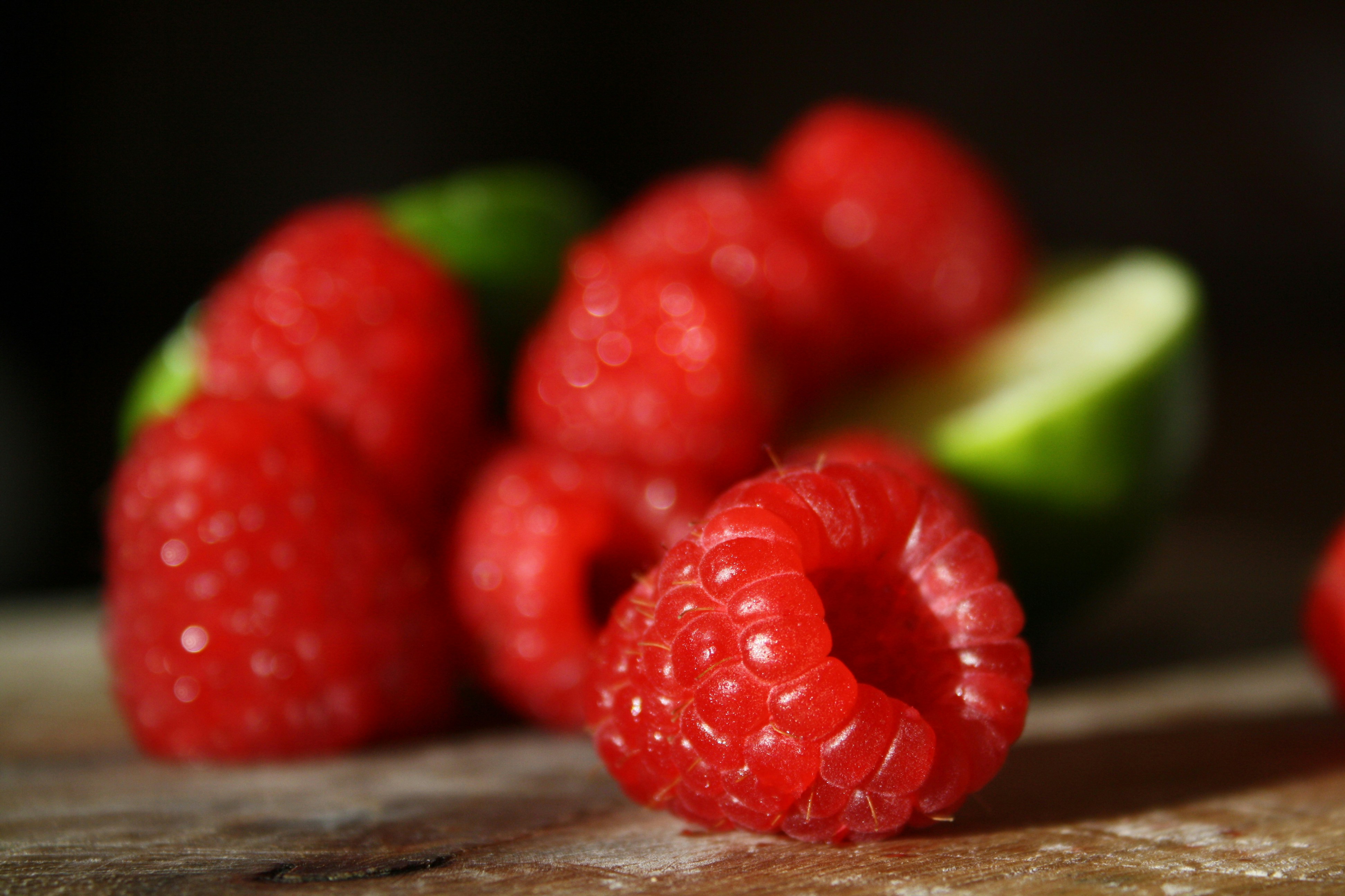 Raspberries and a cucumber on a cutting board photo – Free Fruit Image ...