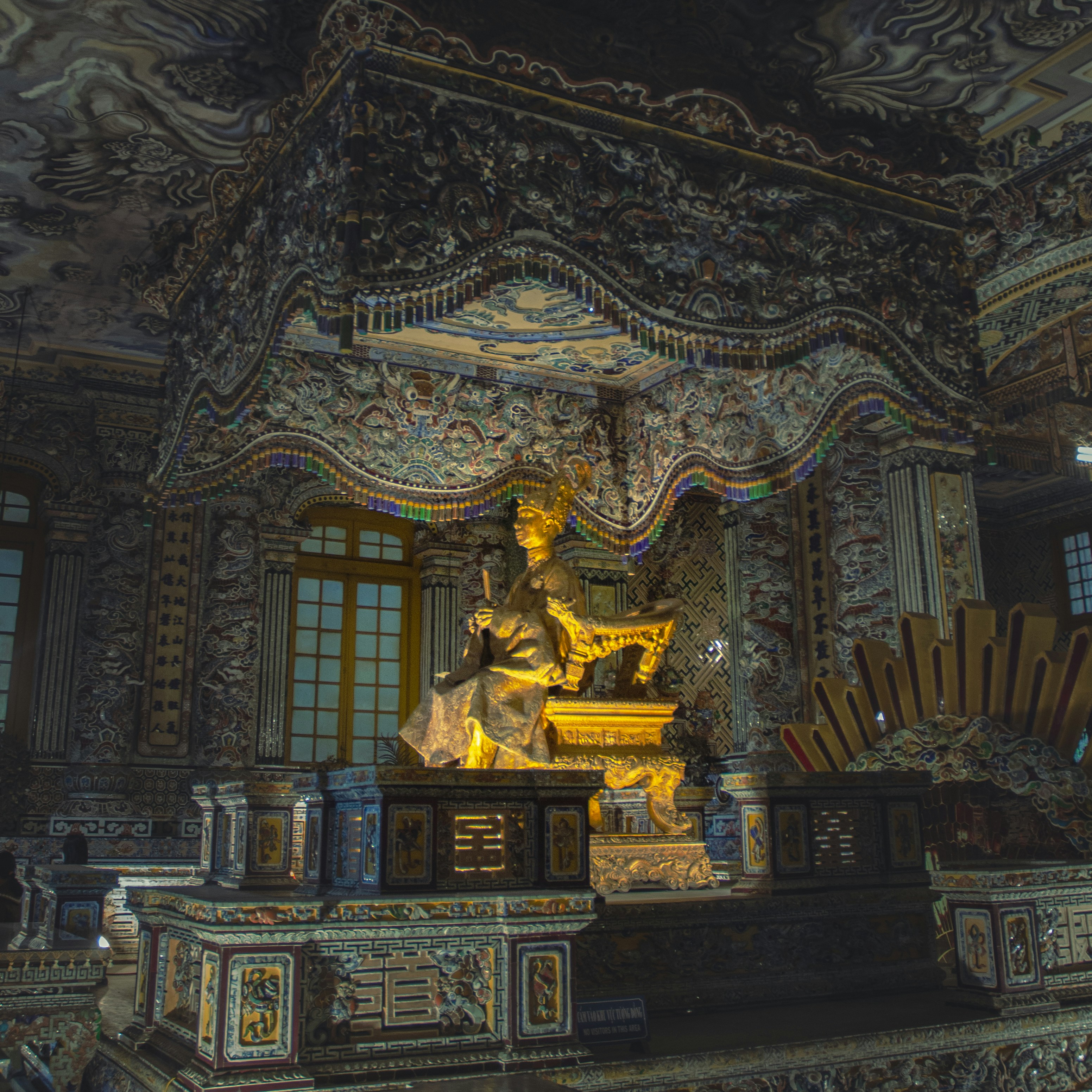 Gilded Guardian Amid a Tapestry of Tiles in a Ceramics-Patterned Temple