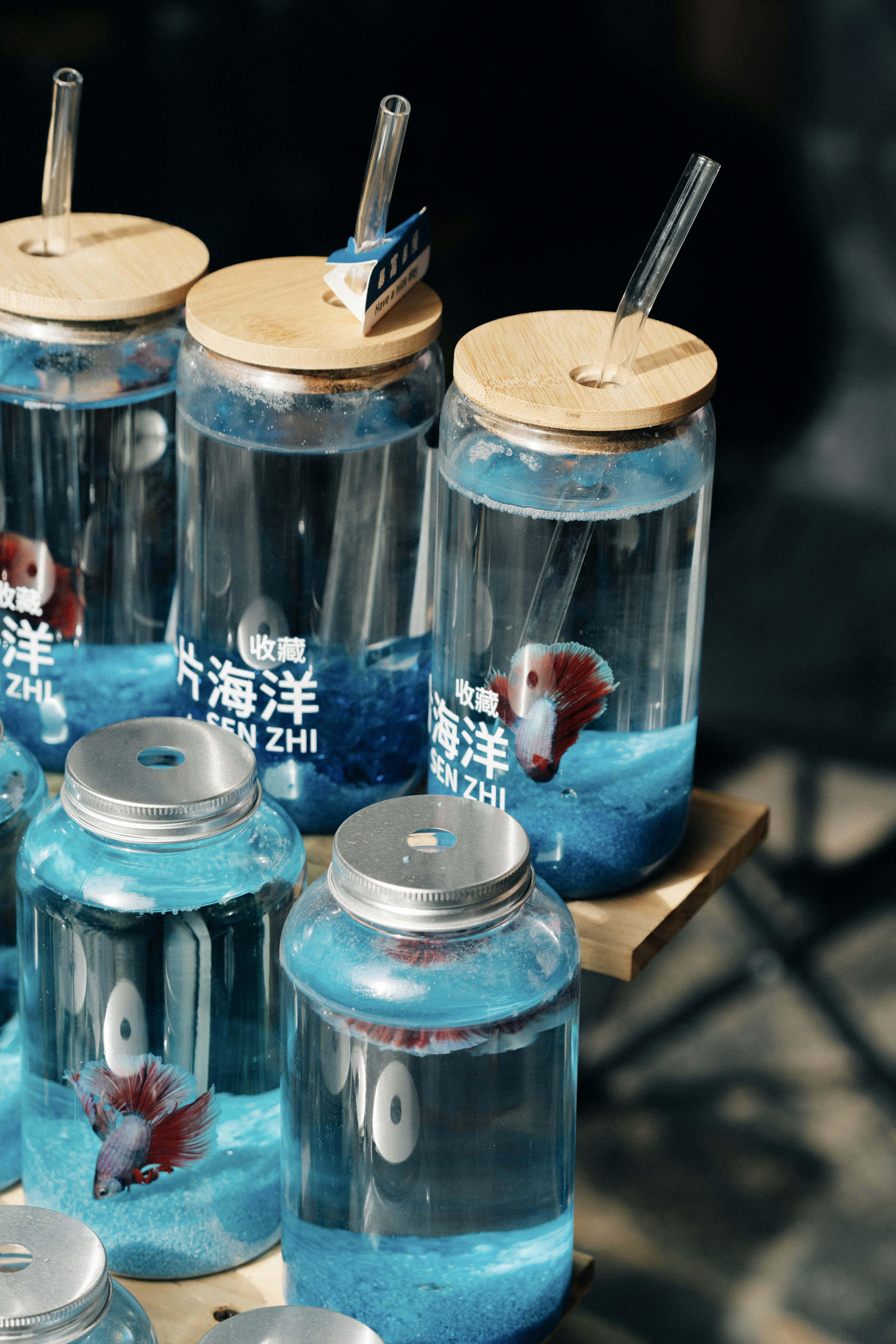 Blue Sand Bottles on Wood: Quiet Glass Still-Life with Straws