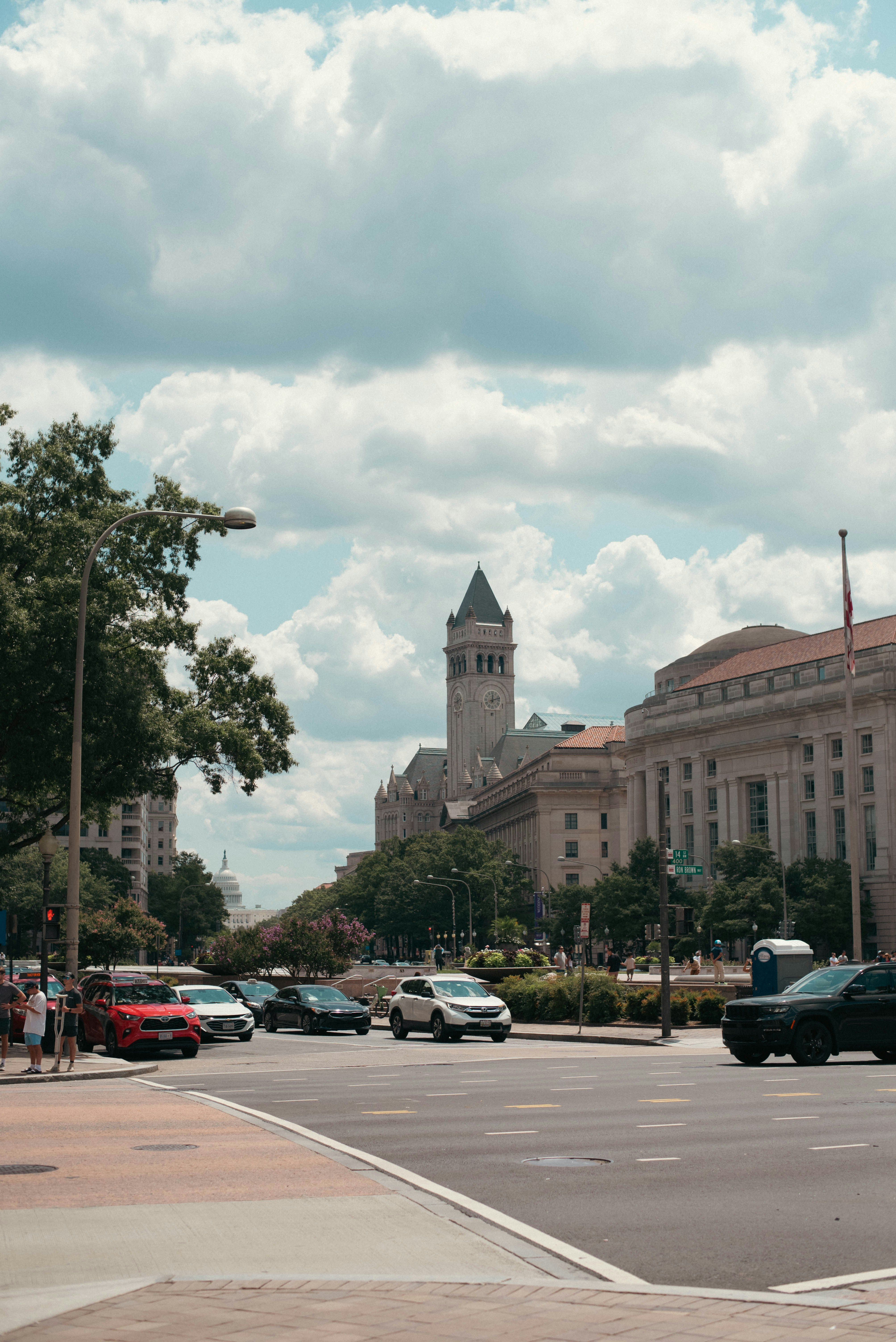 Clock Tower Rising Over a Busy Downtown Street