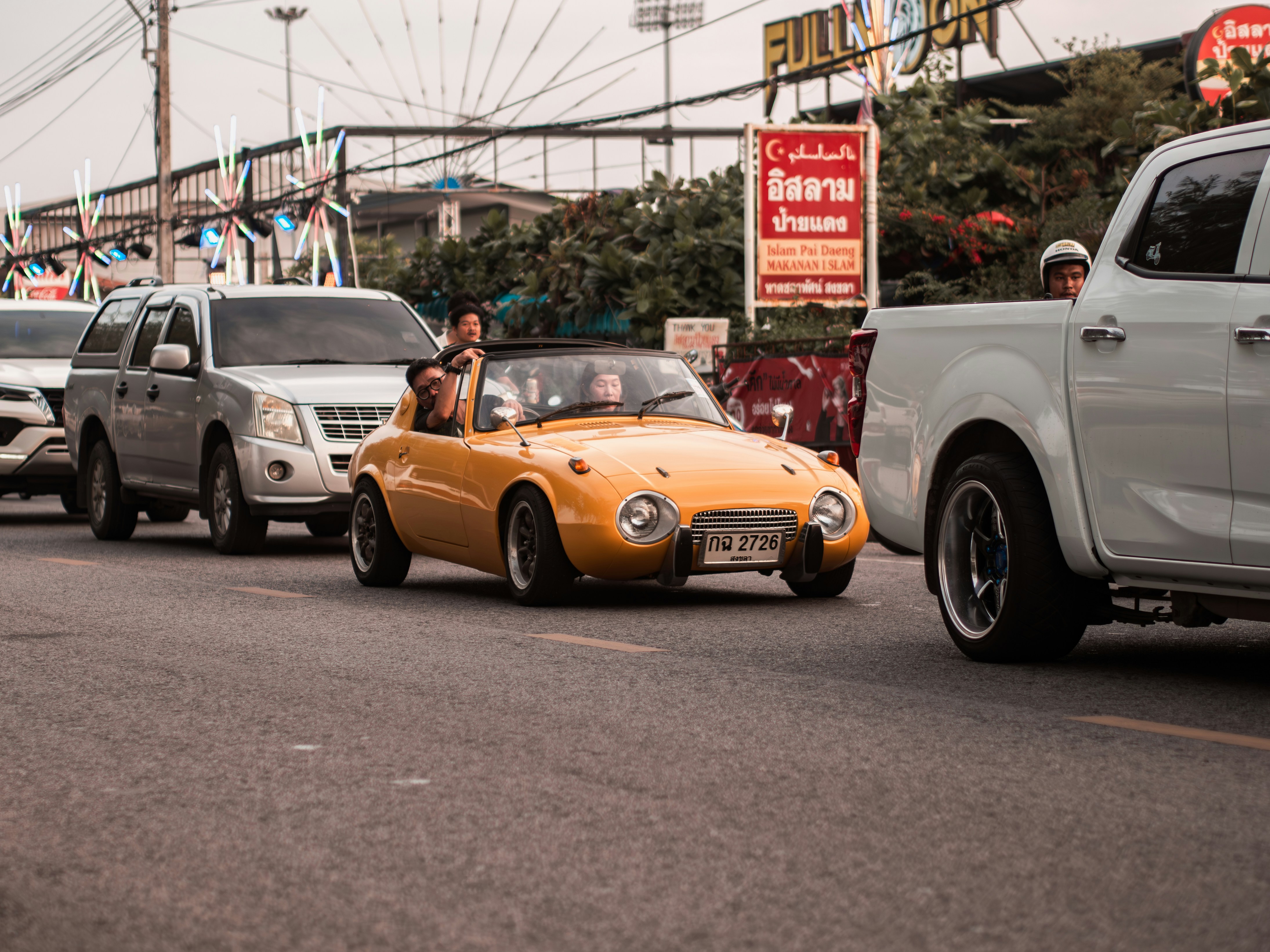Yellow Roadster Emerges Between Urban Gears