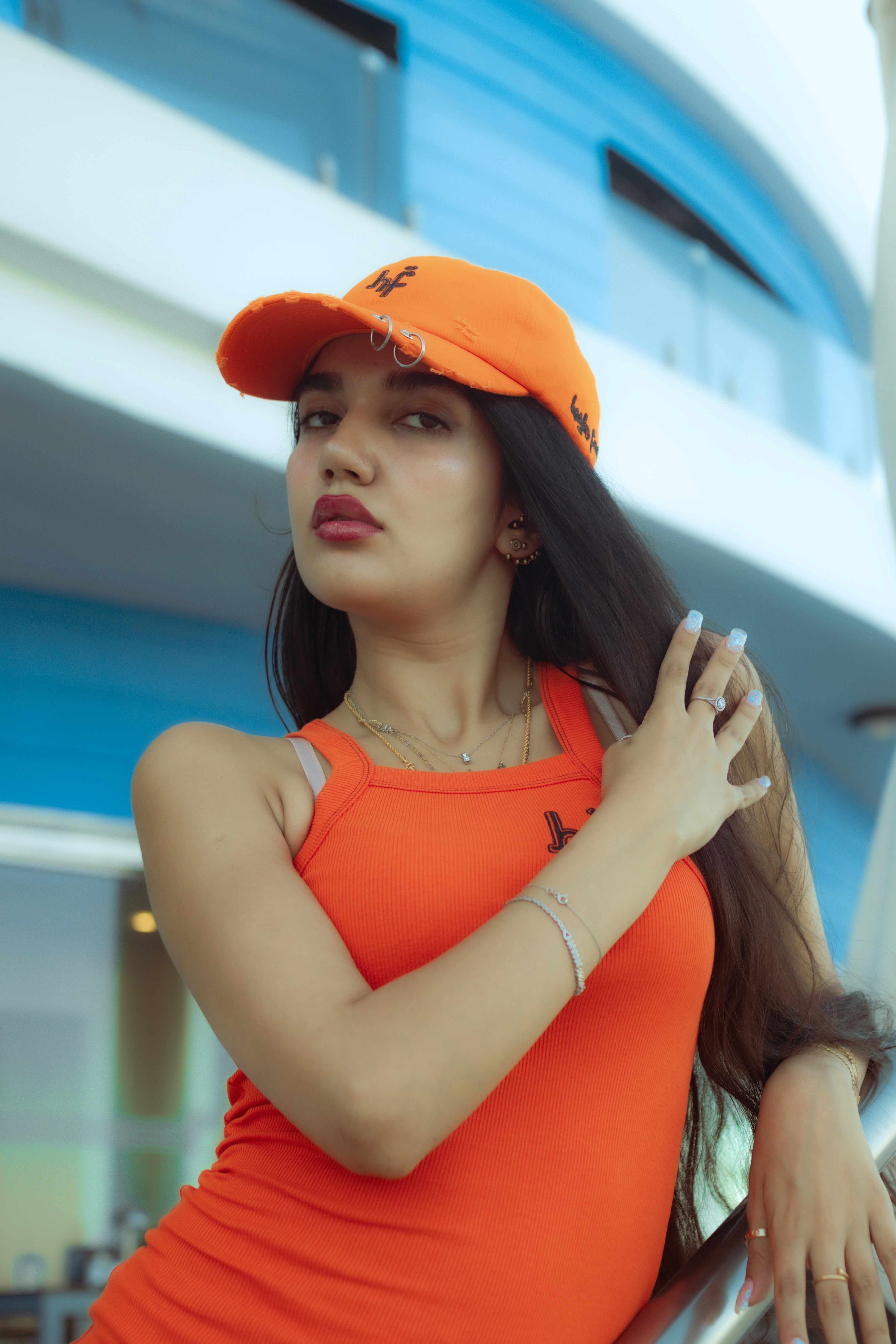 Orange on Blue: A Sharp Portrait Against a Cobalt Urban Backdrop