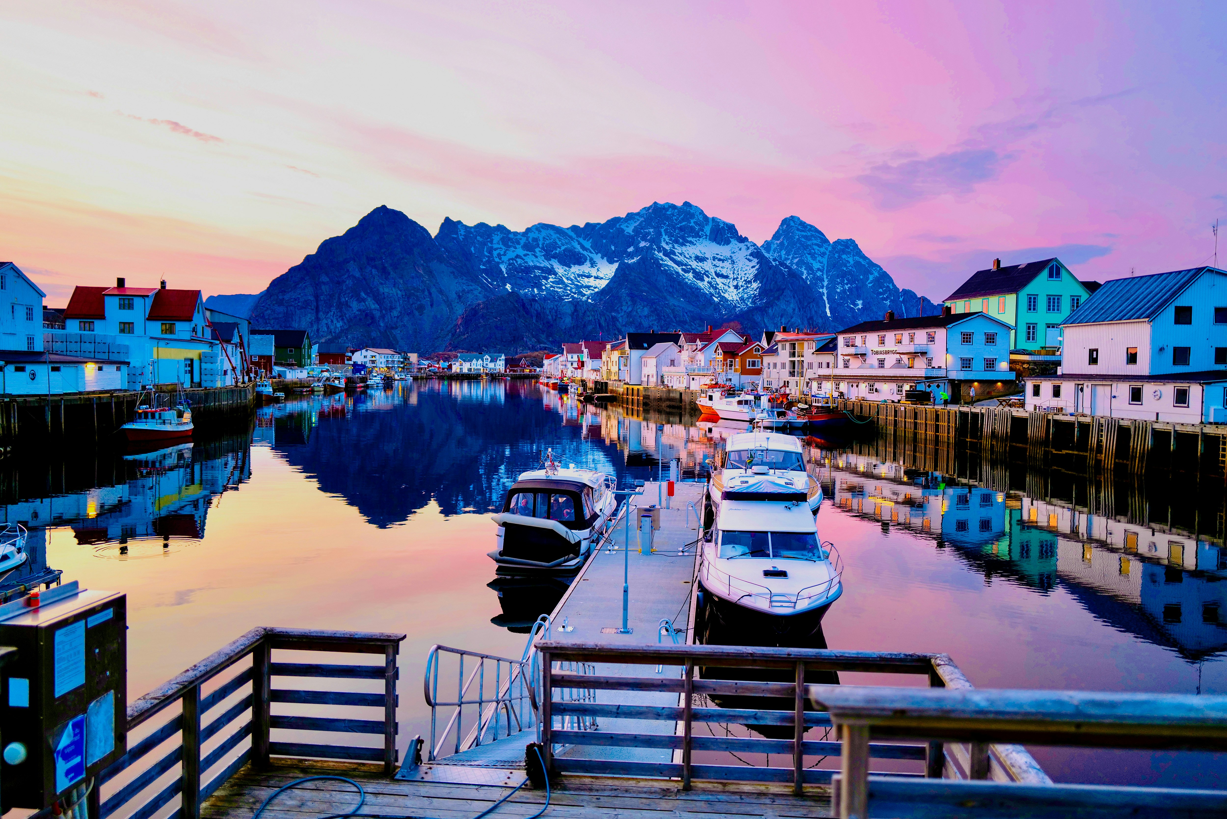 Pastel Harbour: Boats Rest at Dusk Beneath Alpine Peaks