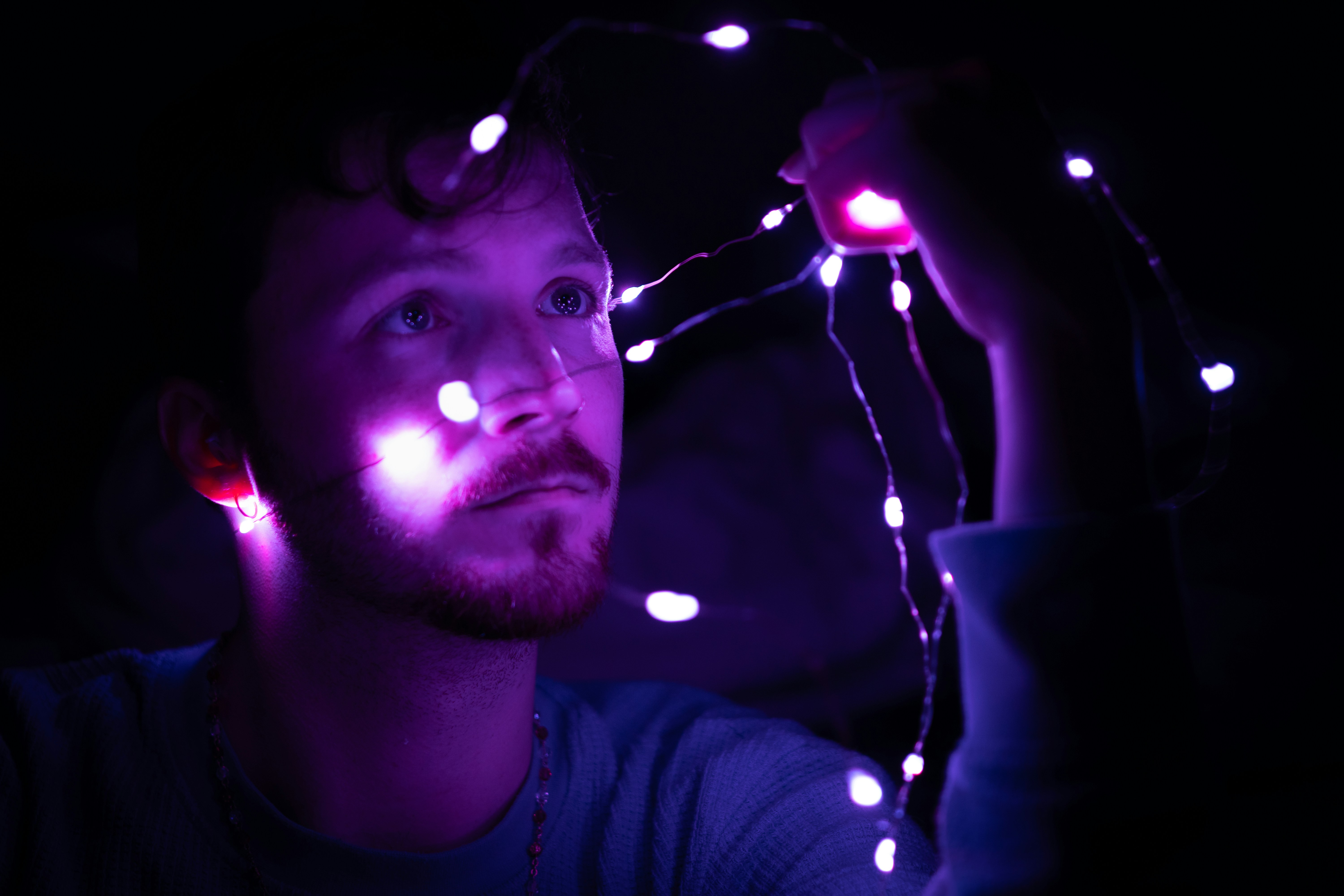 String Lights, Focused Wonder: A Portrait in Purple Glow