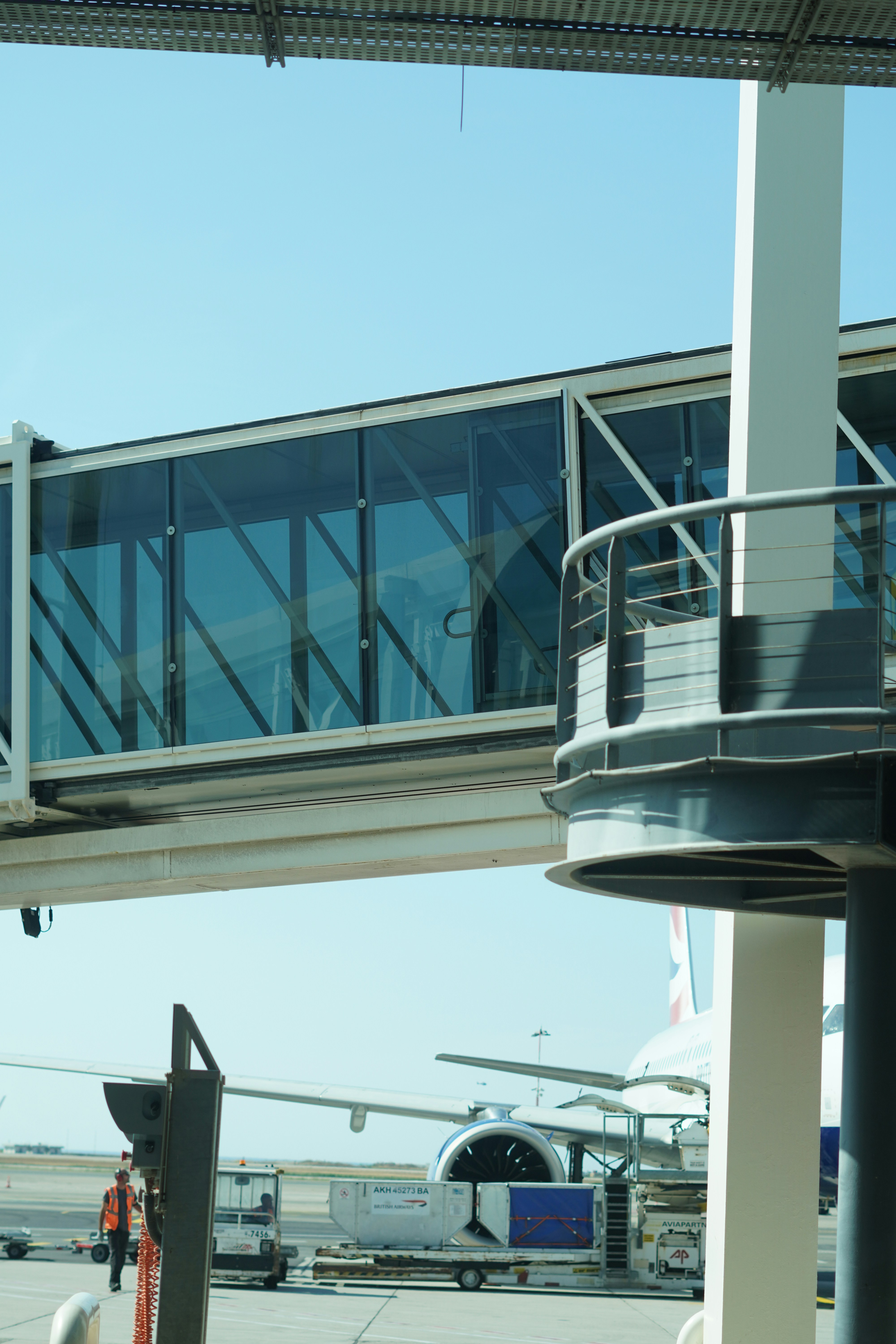 Glass Skywalk Over the Tarmac: Gate, Jet, and Quiet Rhythm