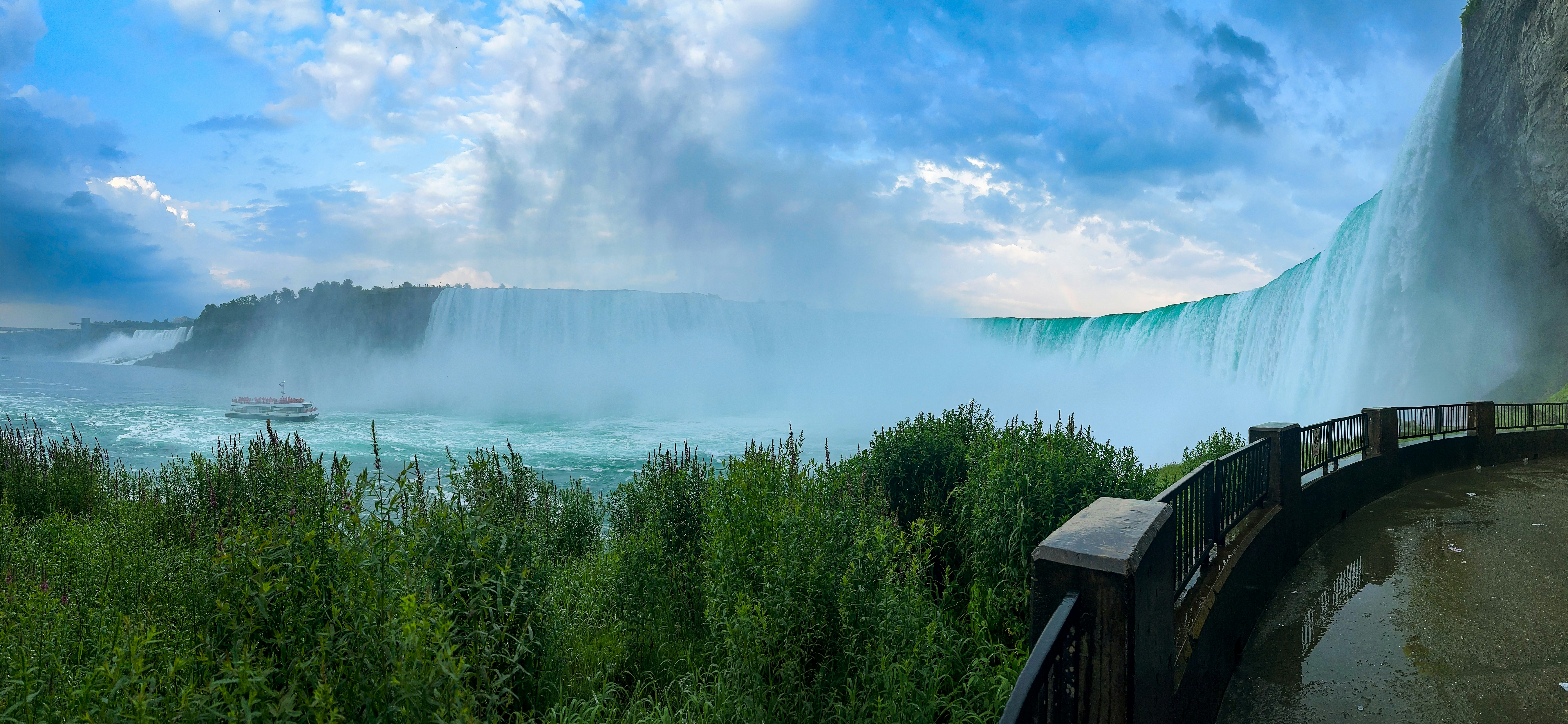 Turquoise Cascade Looms Through Morning Mist from a Riverside Overlook