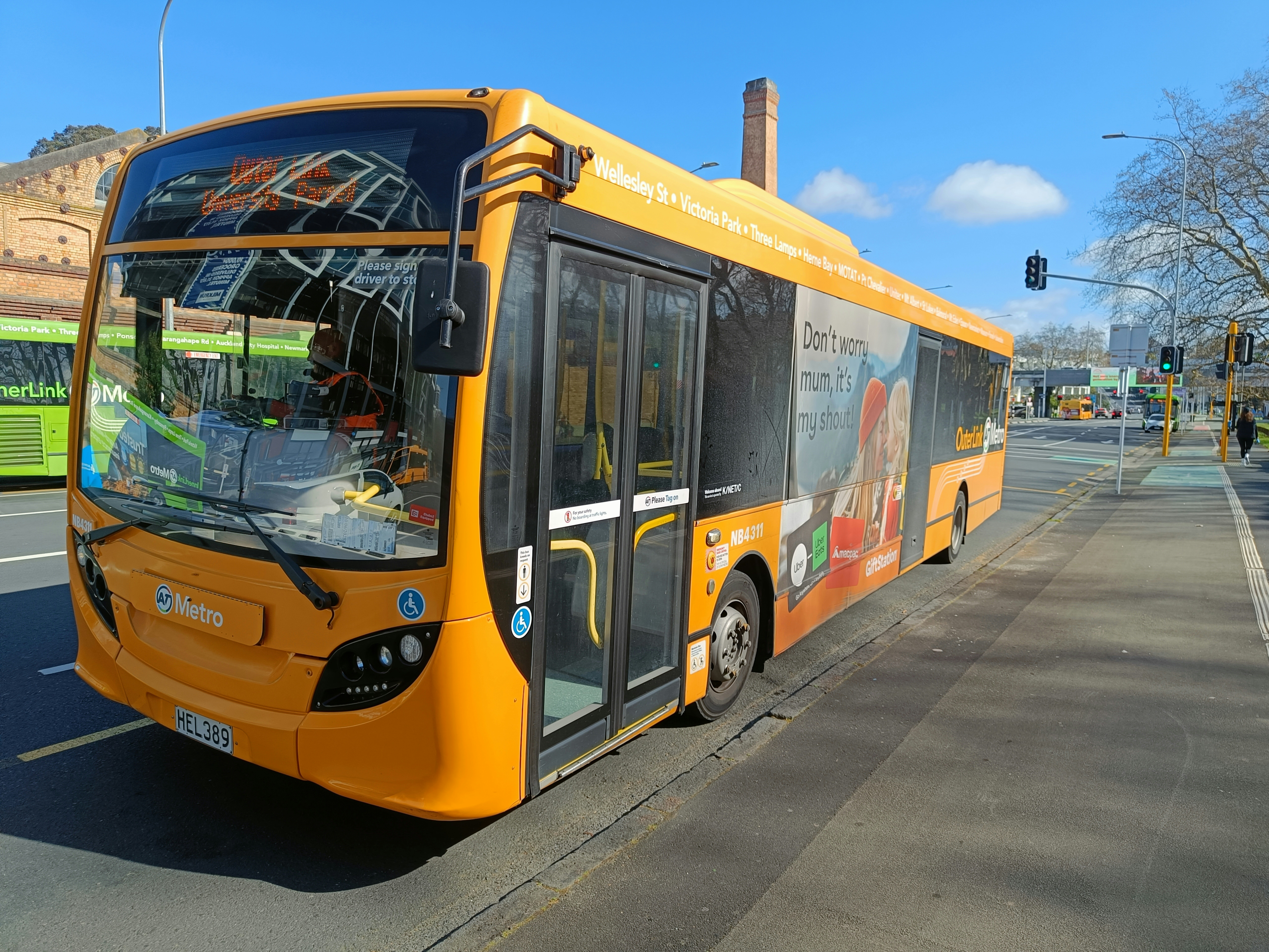 A yellow bus parked on the side of the road photo – Free Car Image on ...