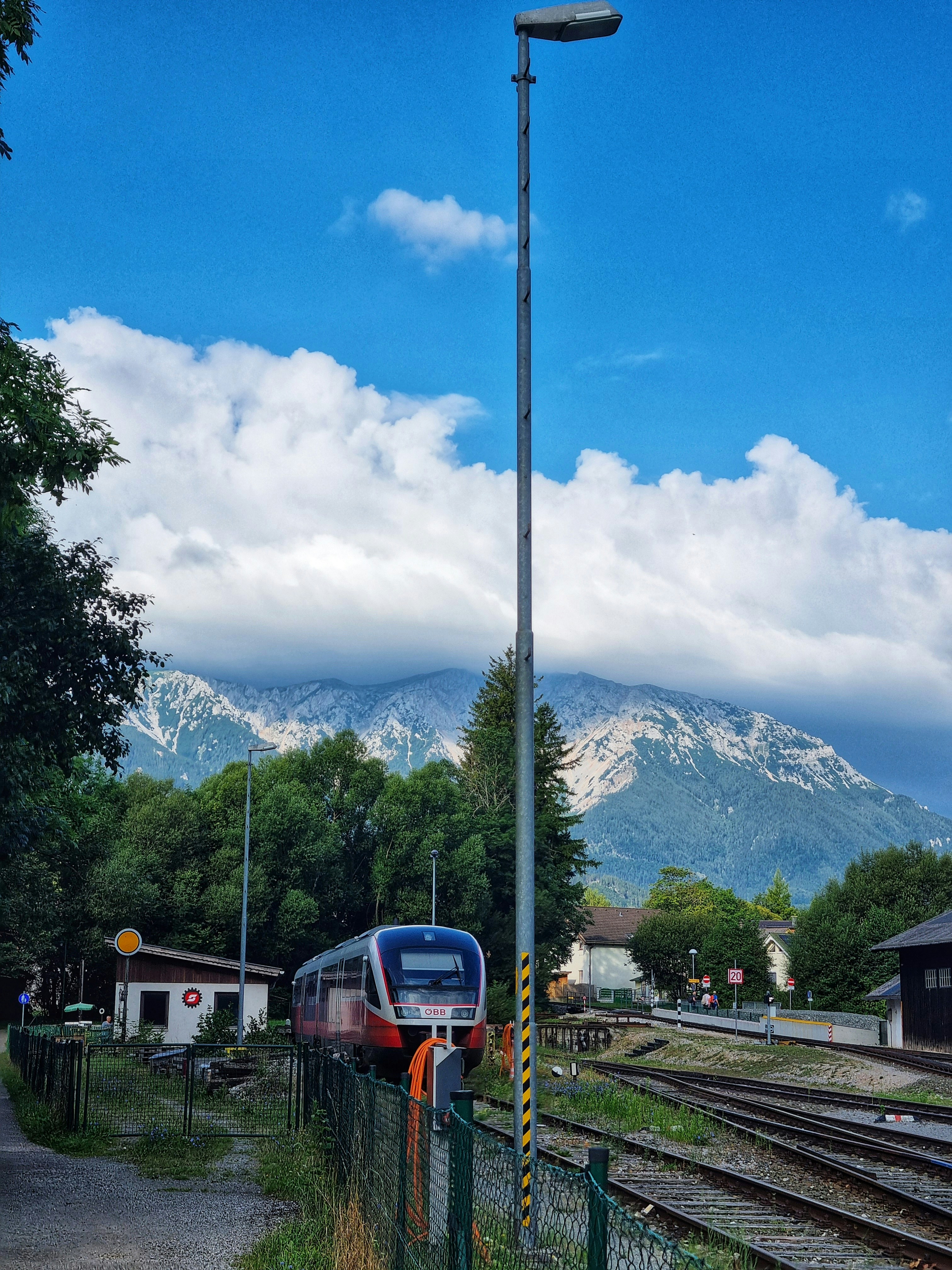 Alpine Spur: Train at the Foot of Snow-Dusted Peaks