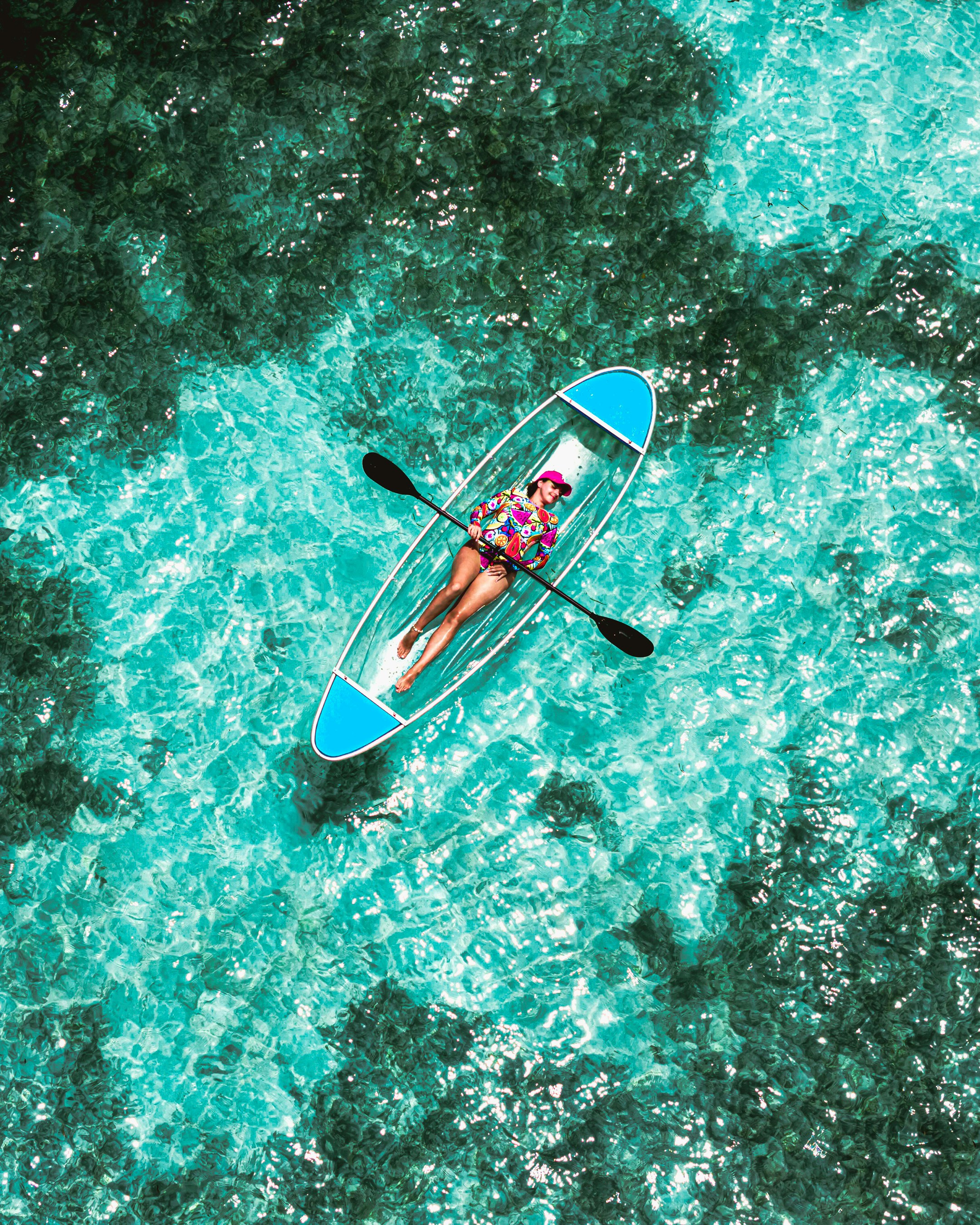 A person in a blue kayak in the middle of the ocean photo – Free ...