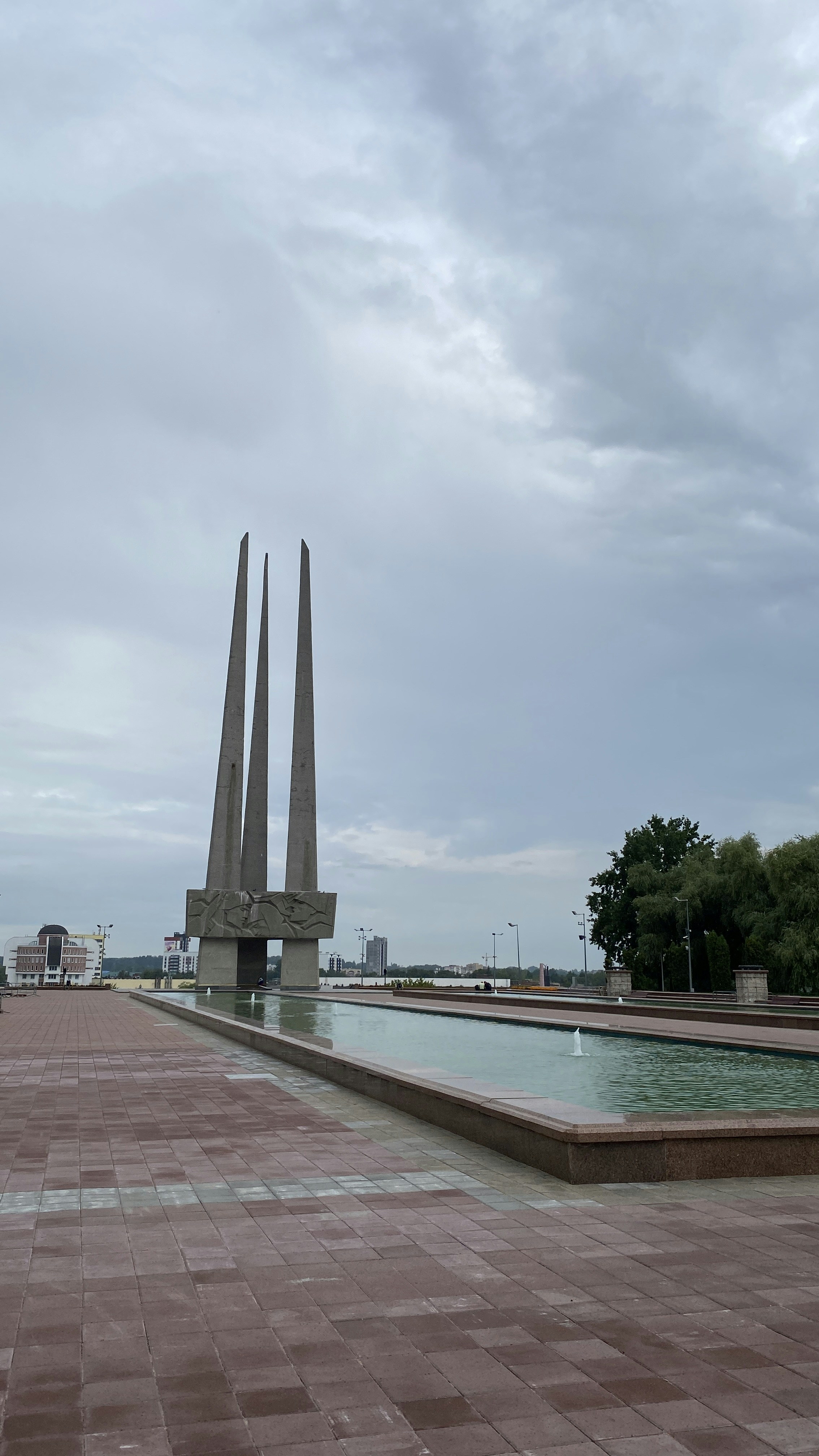 Three Spires Stand Guard Over a Calm, Reflective Plaza