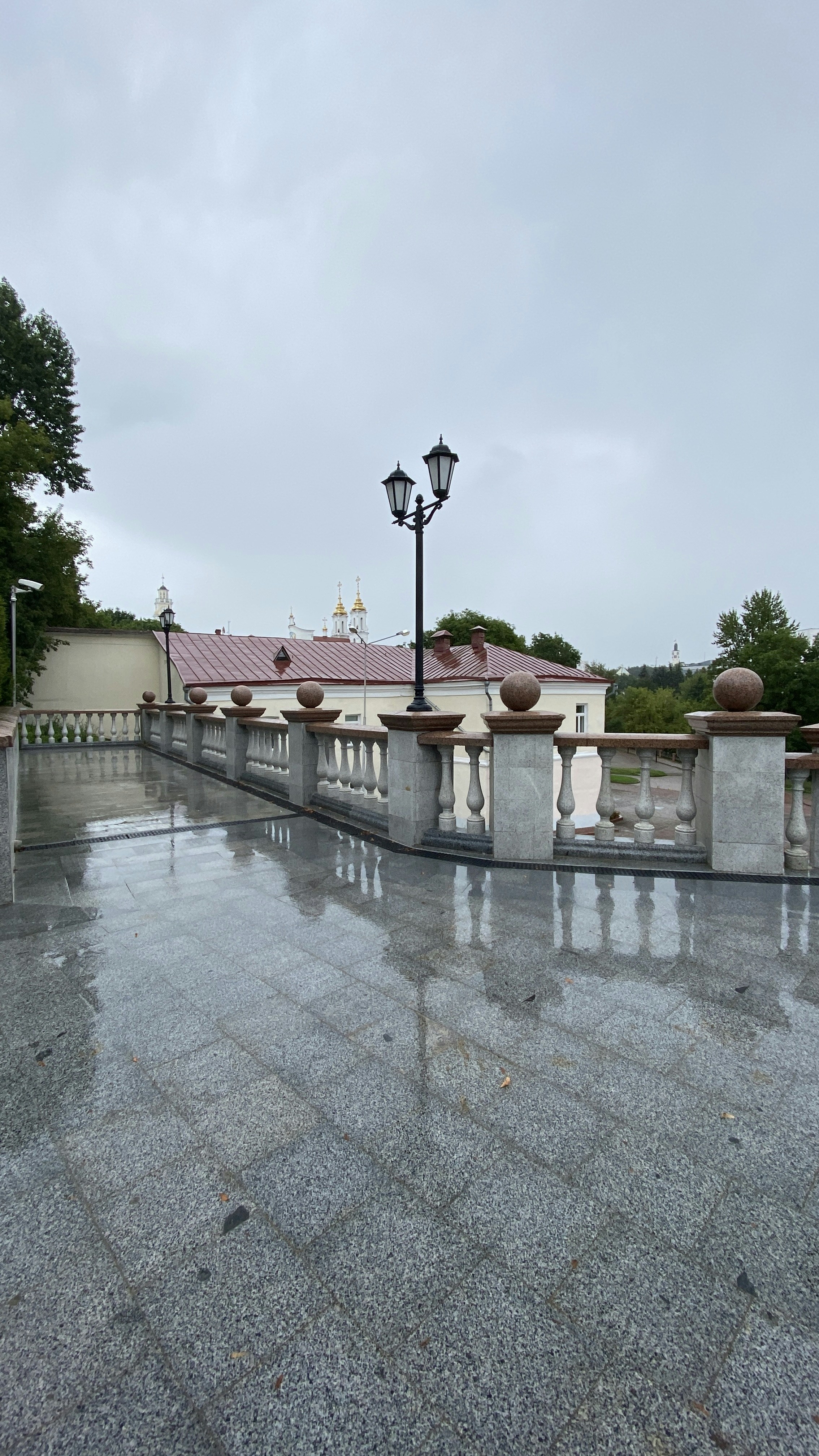 Lamp and Balustrade: Rain-kissed Terrace with Distant Domes