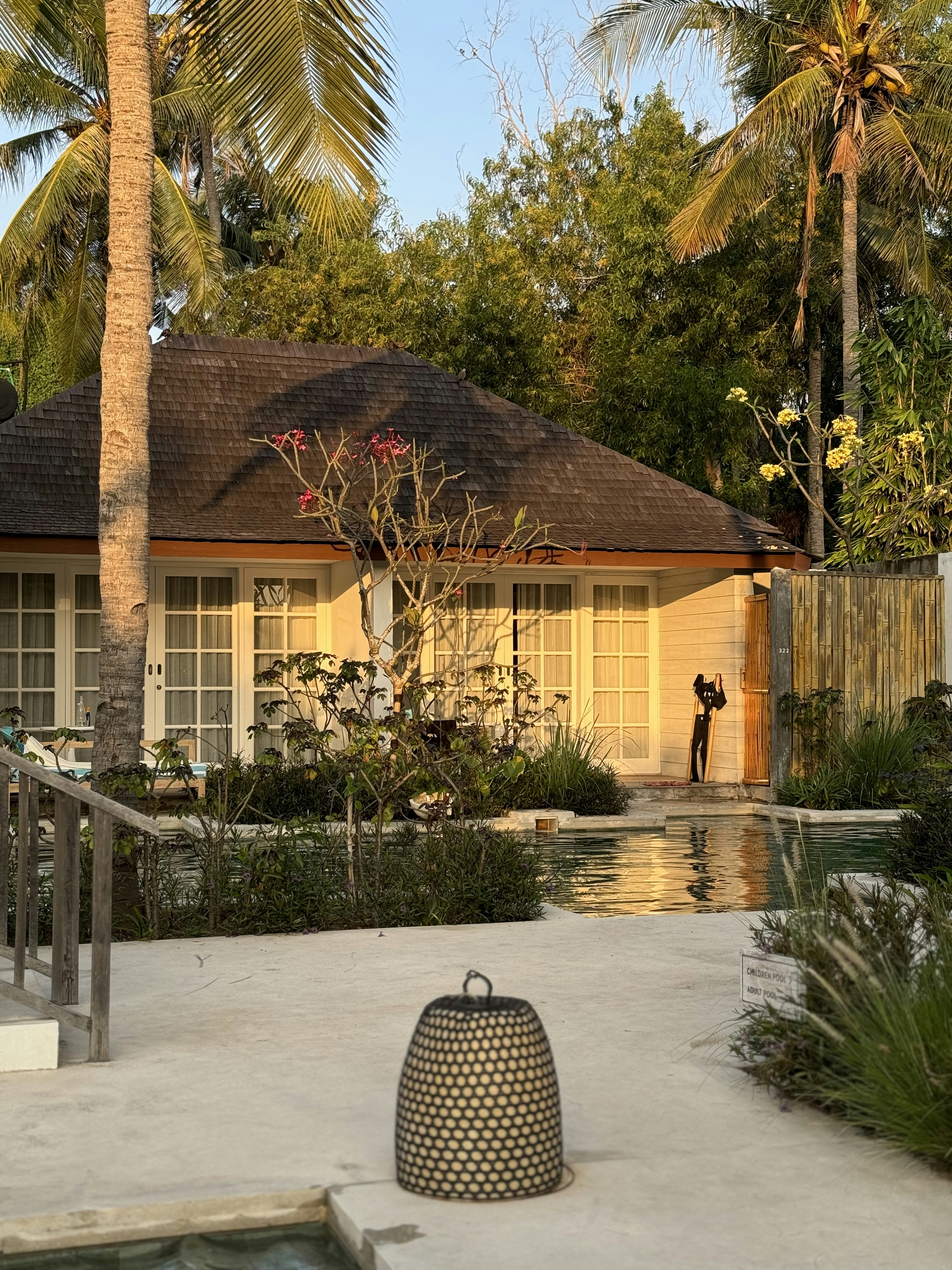 Lantern Light Over a Palm-Fringed Villa at Golden Hour