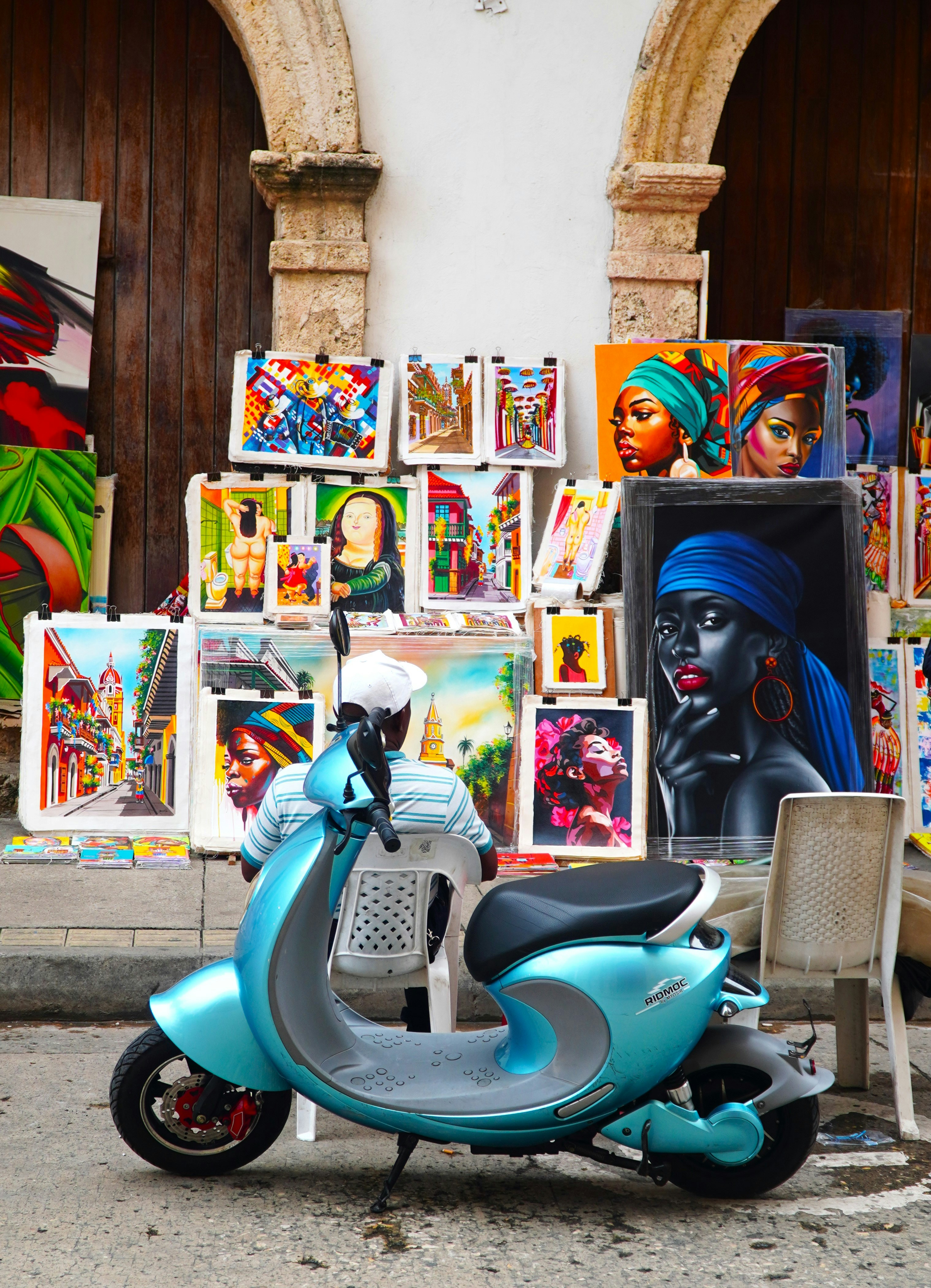 Turquoise Scooter at the Edge of a Kaleidoscopic Canvas Wall
