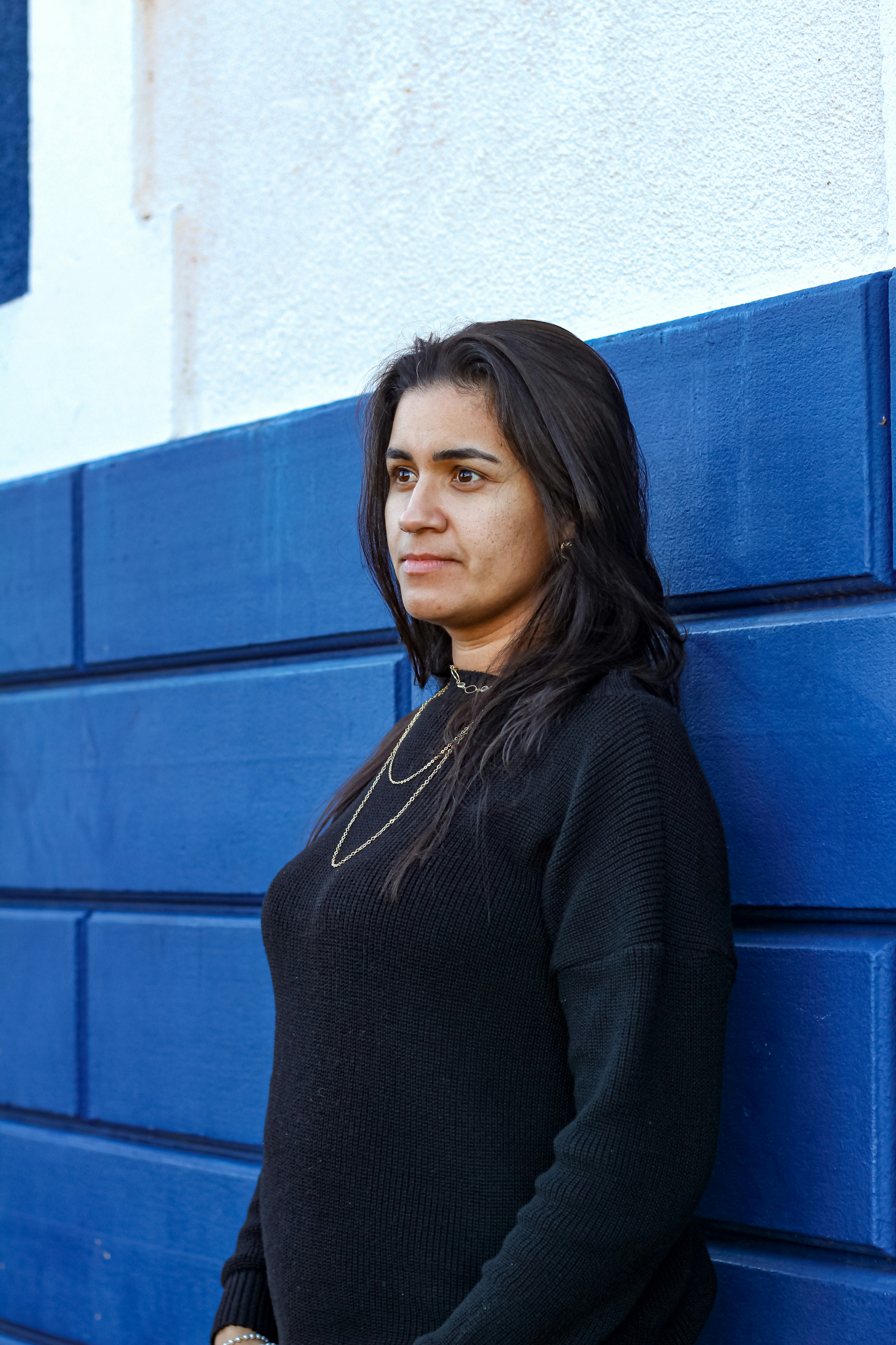 Gaze Beyond the Blue: A Portrait Against Cobalt Paneling