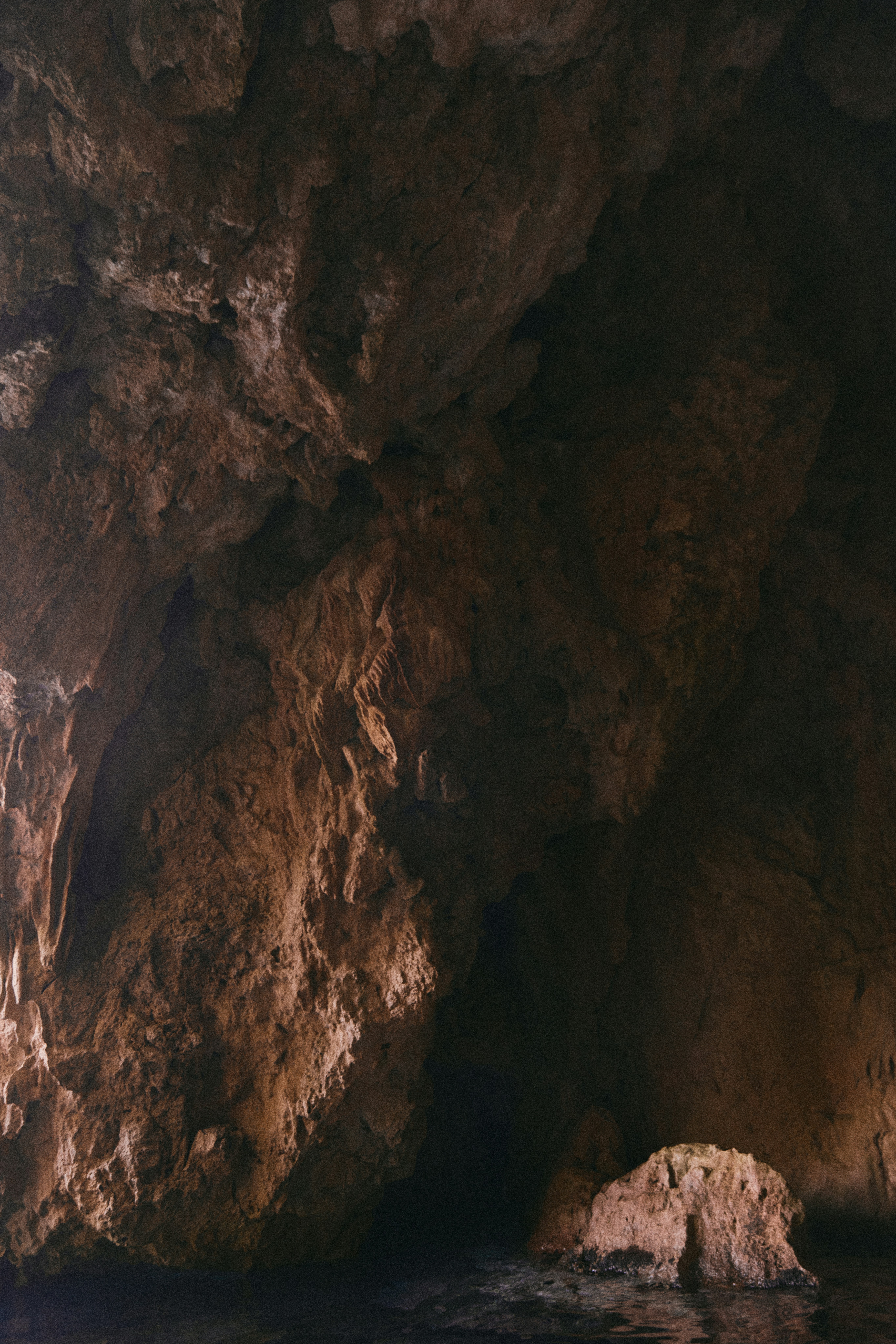 A man standing in a cave next to a body of water photo – Free Corfu ...