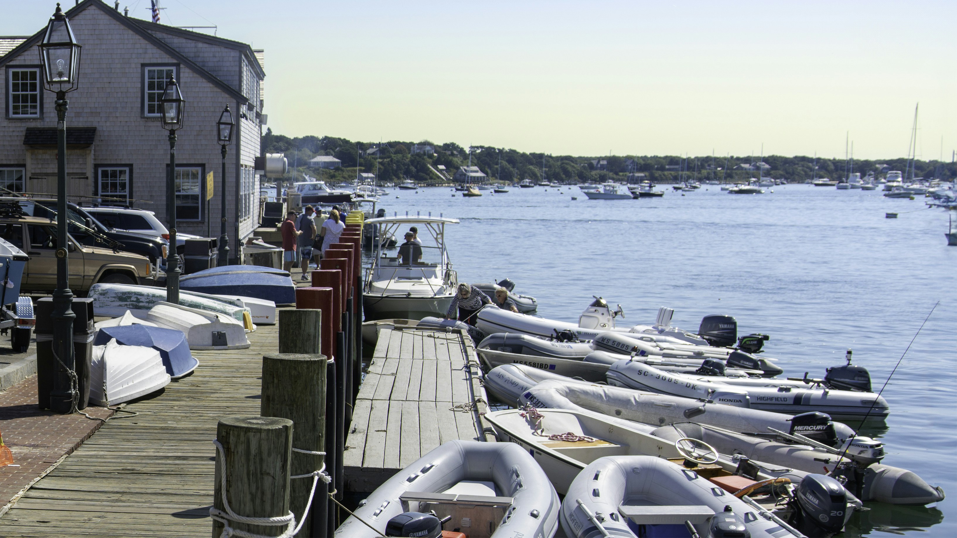 A harbor filled with lots of boats next to a building photo – Free ...