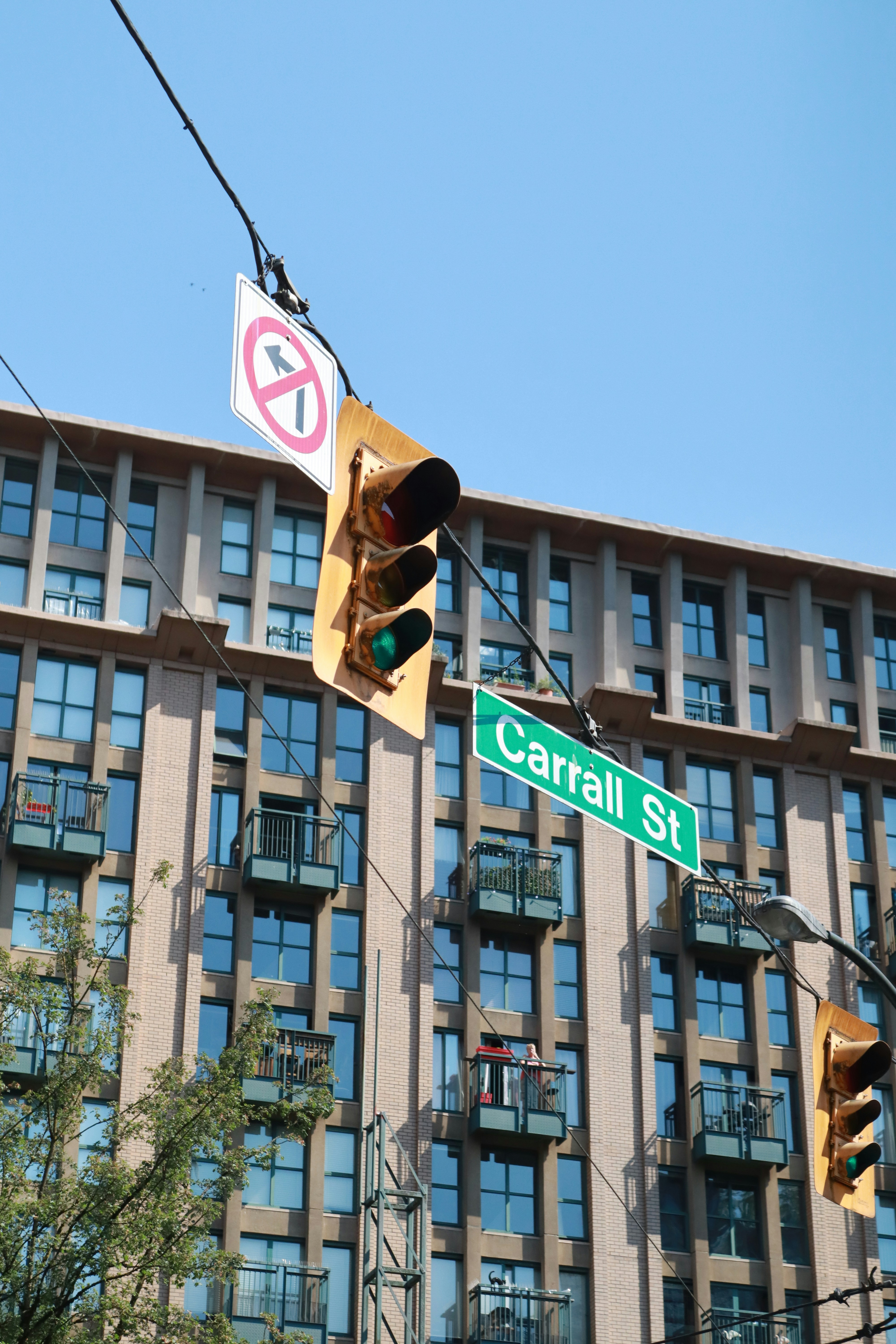 Carrall Street Signals Framed by Brick Facades Under a Clear Blue Sky